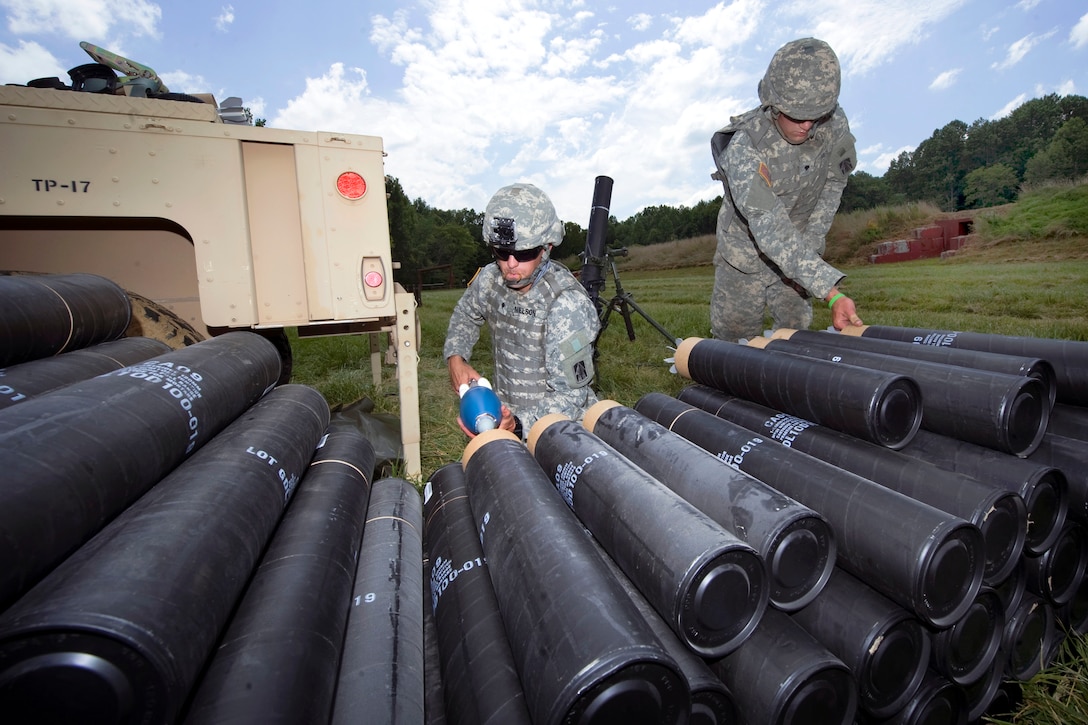 Army Spcs. Brian Nelson, left, and Robert Davis prepare 120mm mortar ...