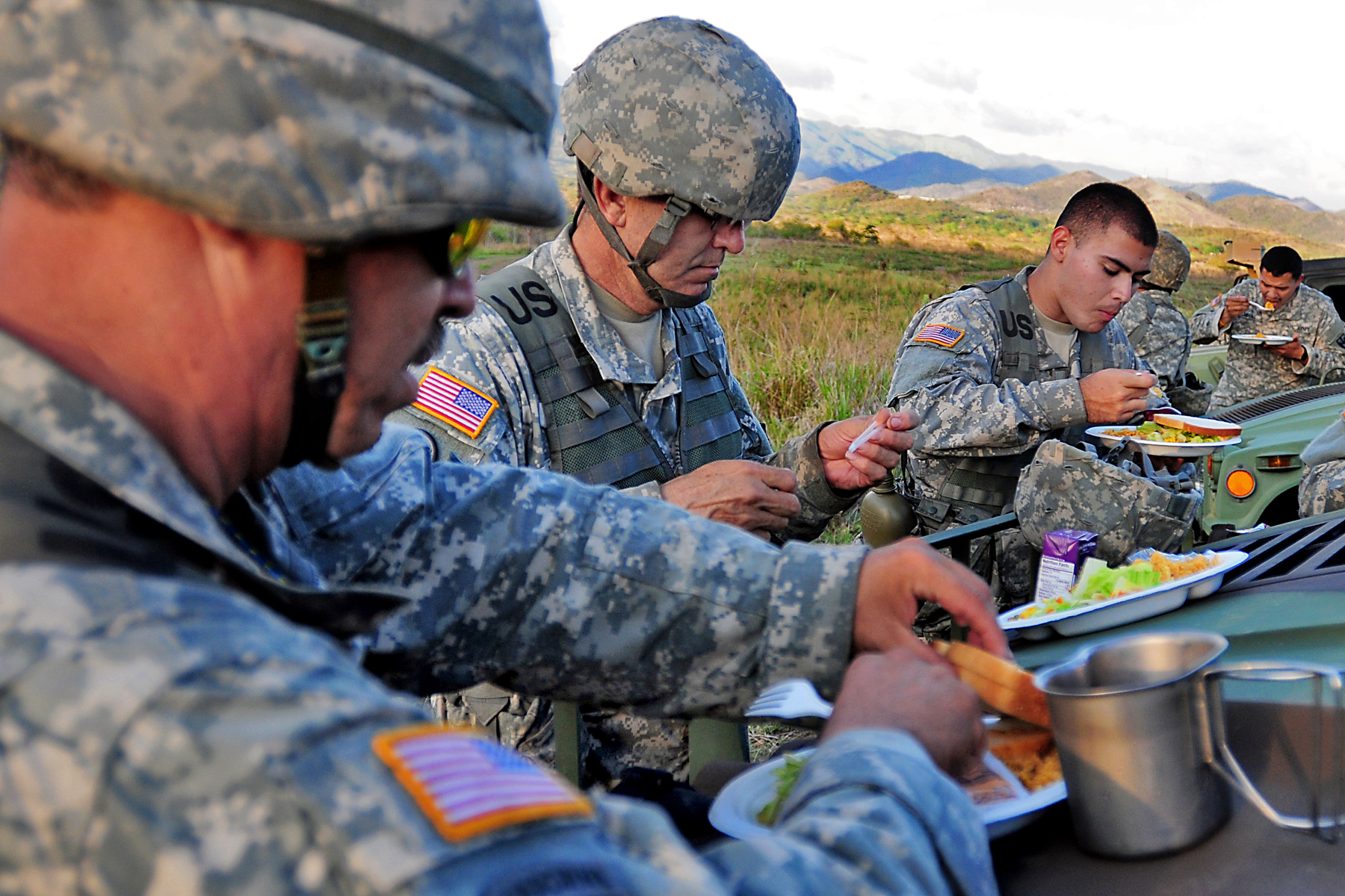 Soldiers eat dinner in the field after completing their training ...