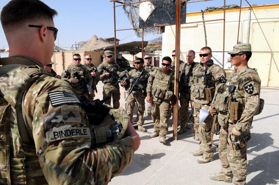 U.S. Army 1st Lt. Eugene Kwag, right, gives a pre-mission briefing to troops before departing ...