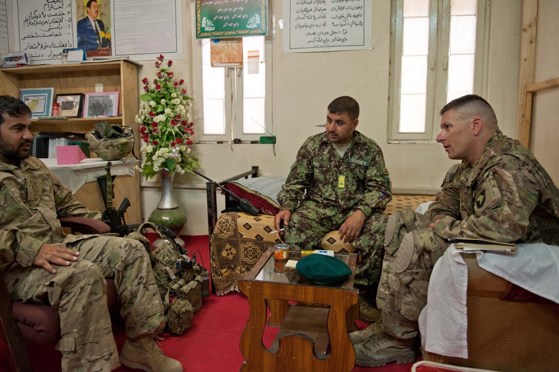 U.S. Army 1st Sgt. Christopher Henning, right, confers with the Afghan ...