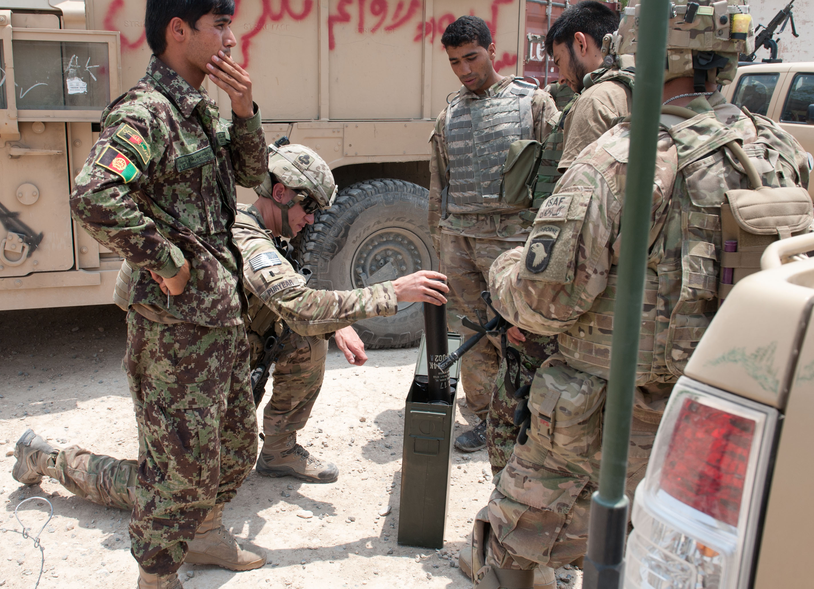 A U.S. soldier examines a container of mortar rounds on former FOB ...