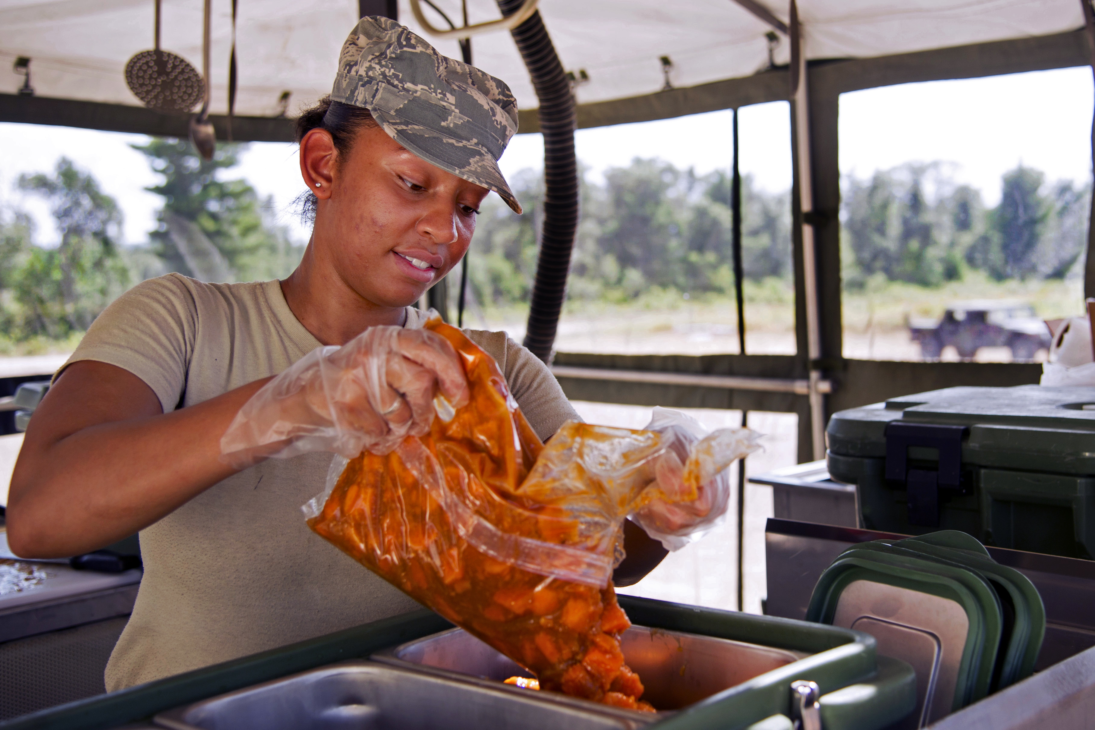 Air Force Senior Airman A'me Coker prepares sweet potatoes for dinner ...