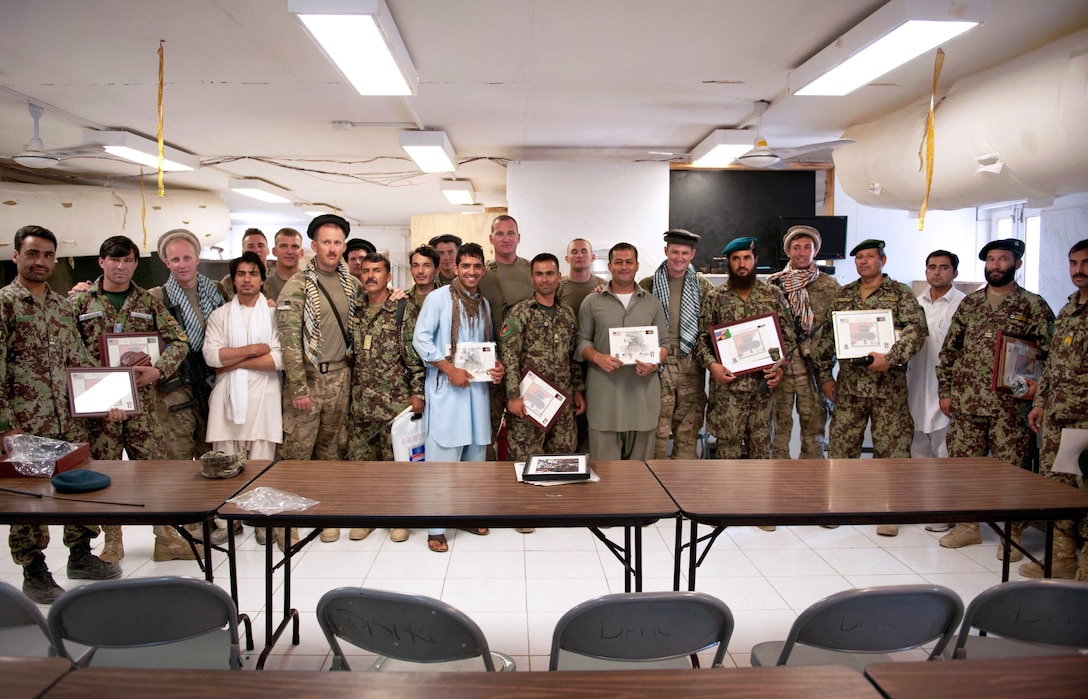 U.S. and Afghan soldiers pose for a photograph on former Forward ...