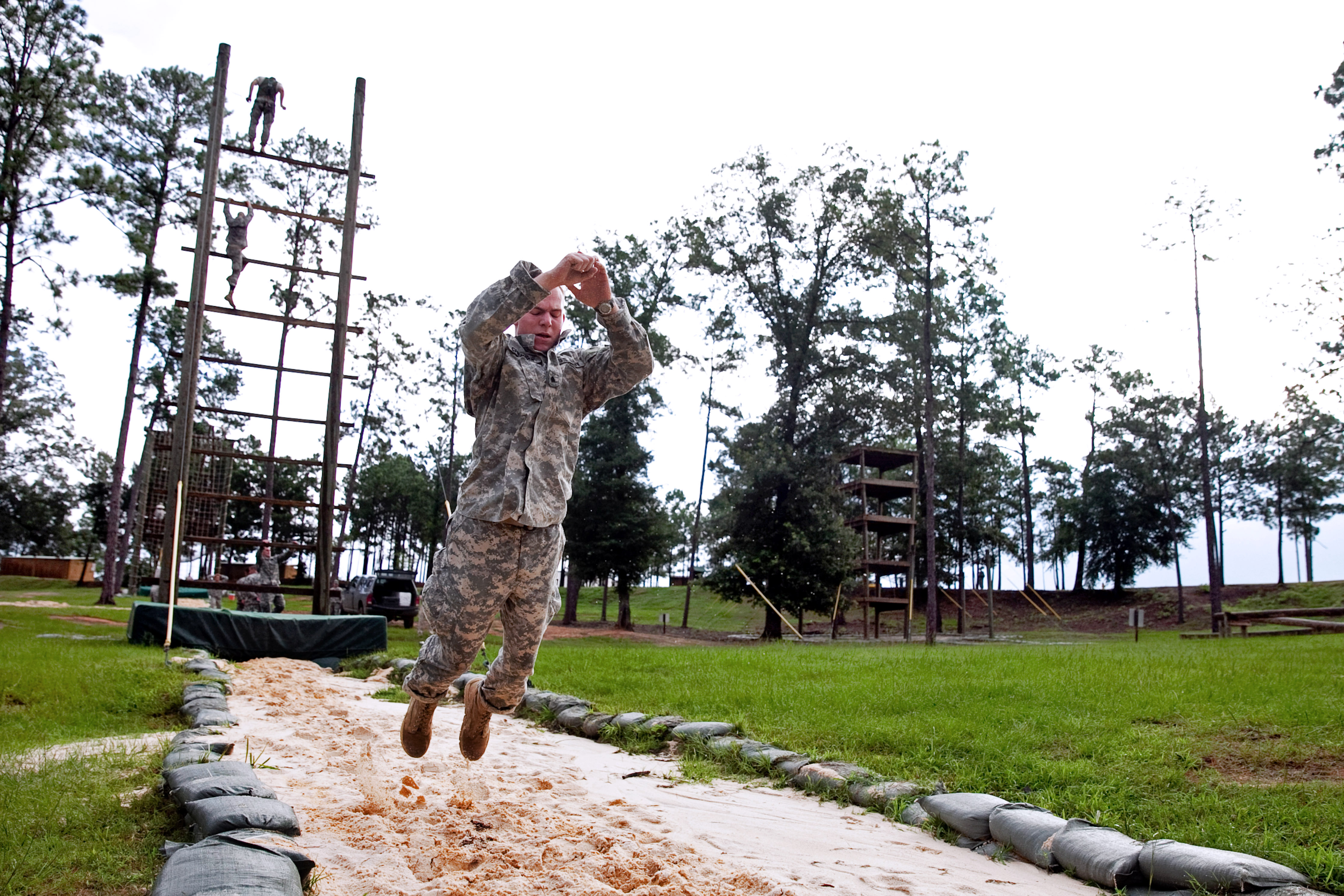 Army cadet Andrew W. Charapko performs broad jumps between obstacles ...