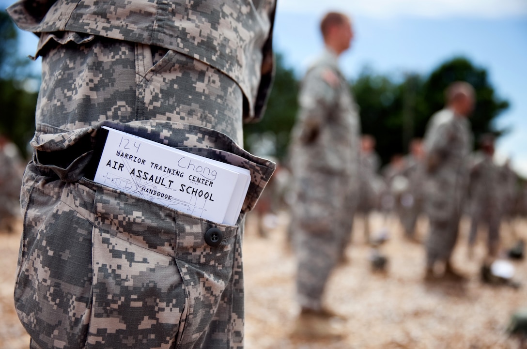 Soldiers and Army cadets stand in formation as they wait for ...