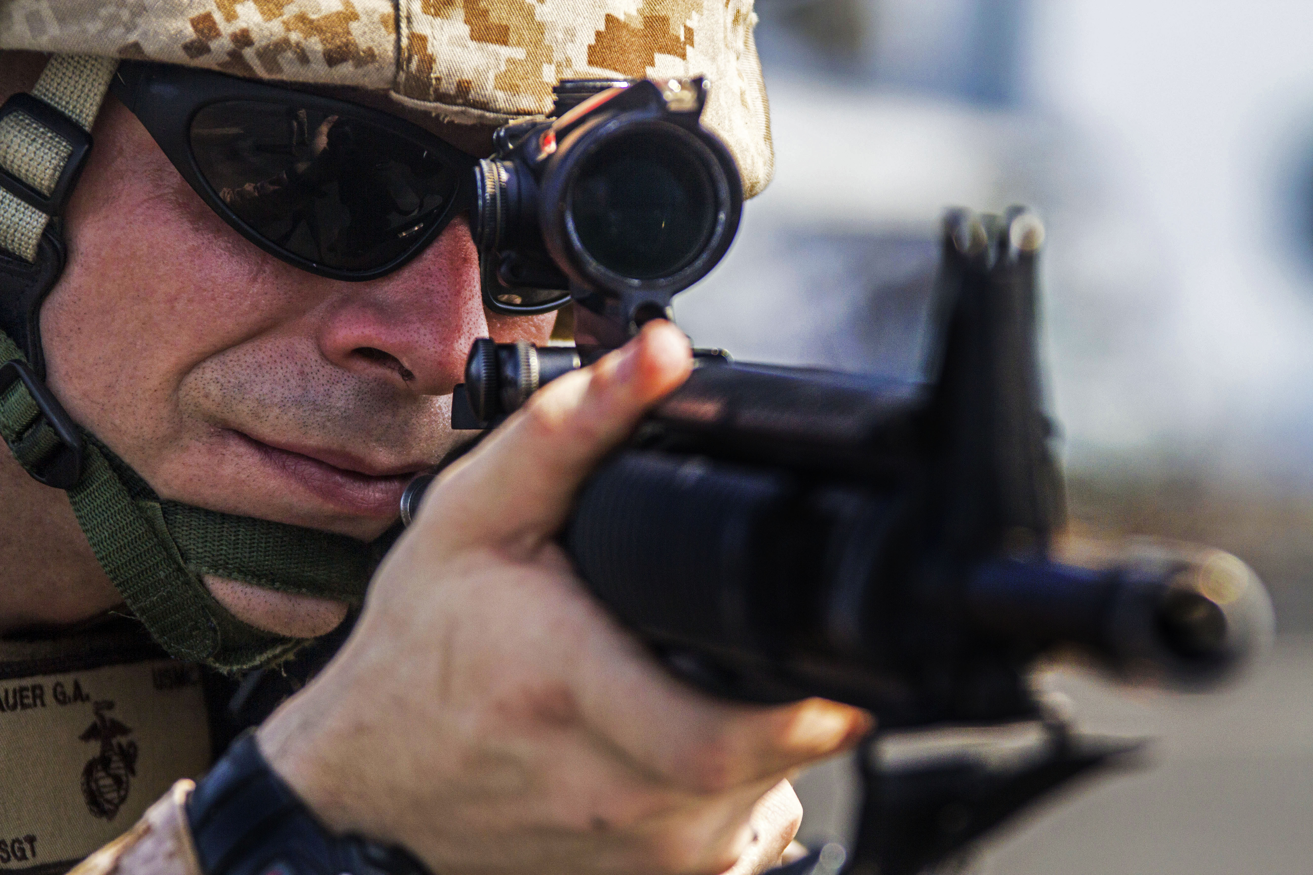 U.S. Marine Corps Sgt. Gregory Bauer fires his weapon during a live ...