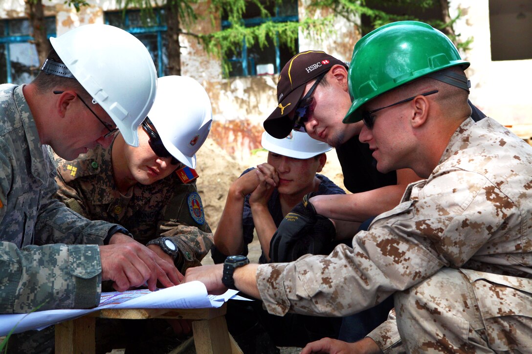 U.S. service members and engineers from Mongolia's armed forces review ...