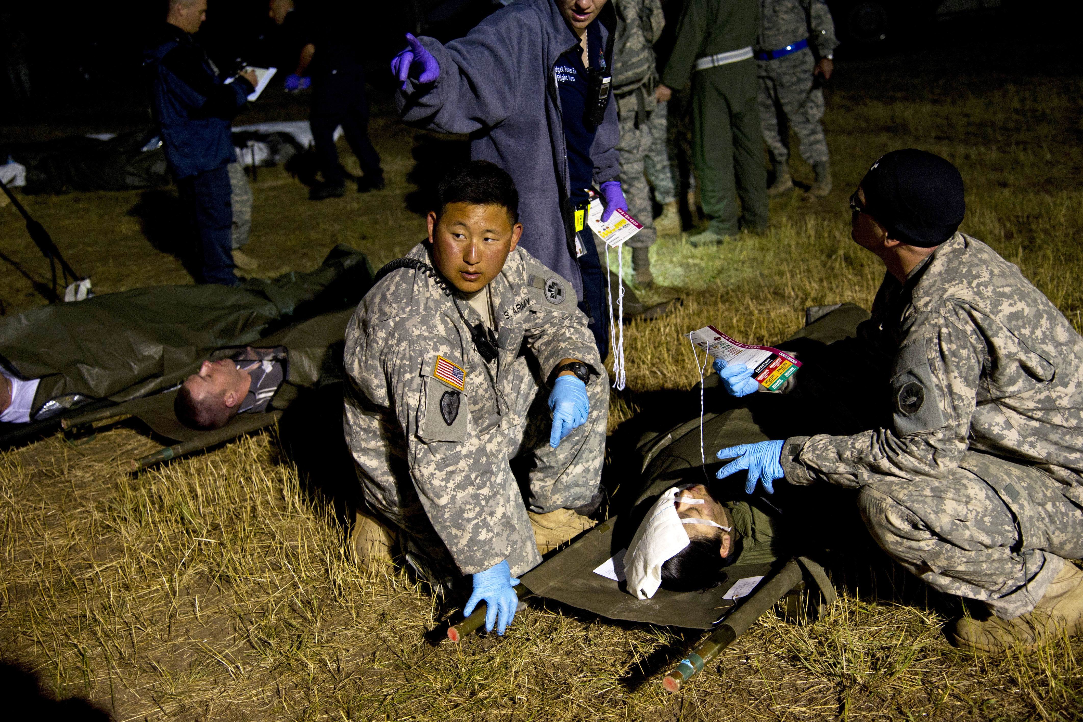Army Sgt. Paul Kim, left, and Cpl. Joshua Donavan, right, prepare to ...