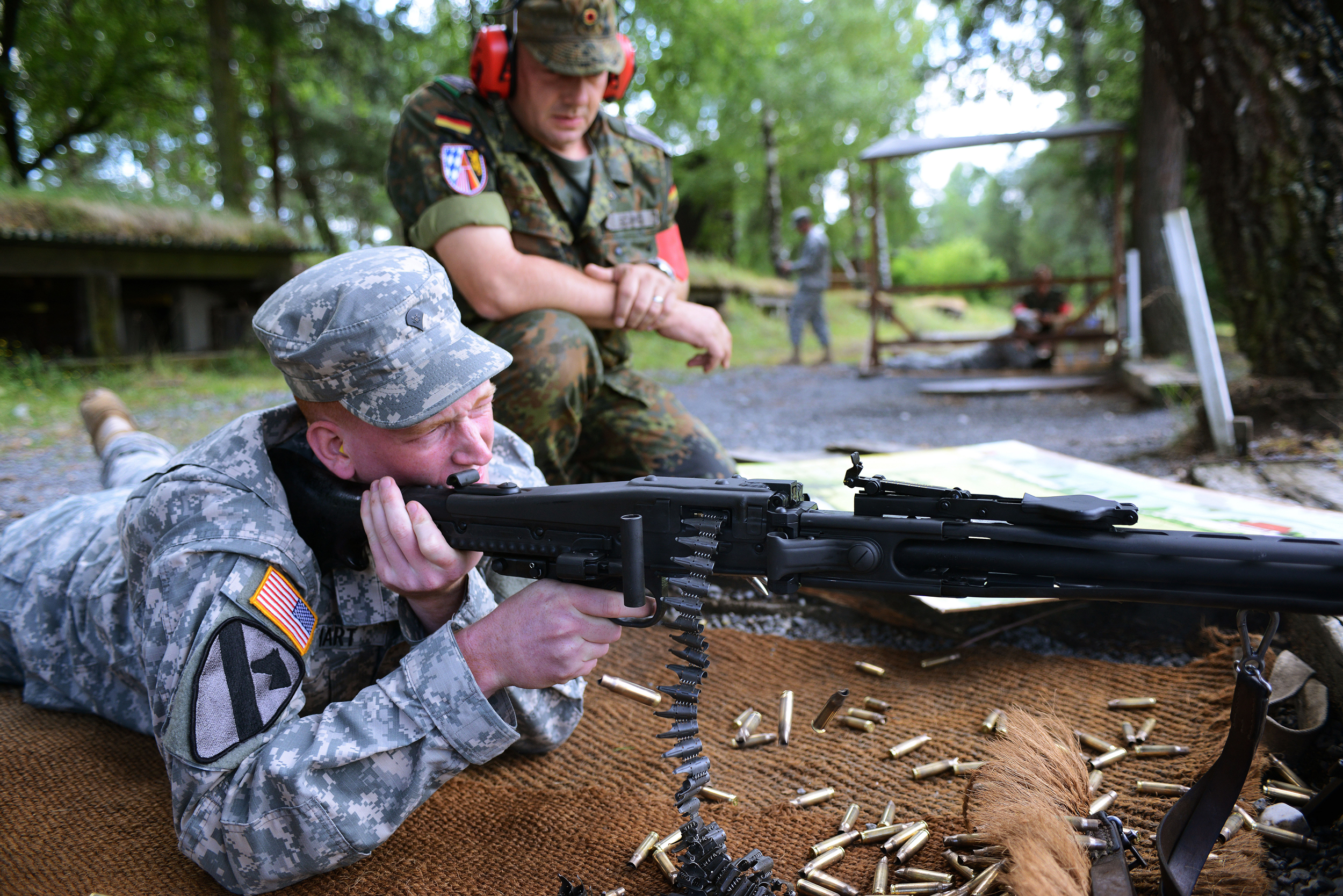 A German army sergeant first class, right, observes U.S. Army Spc ...