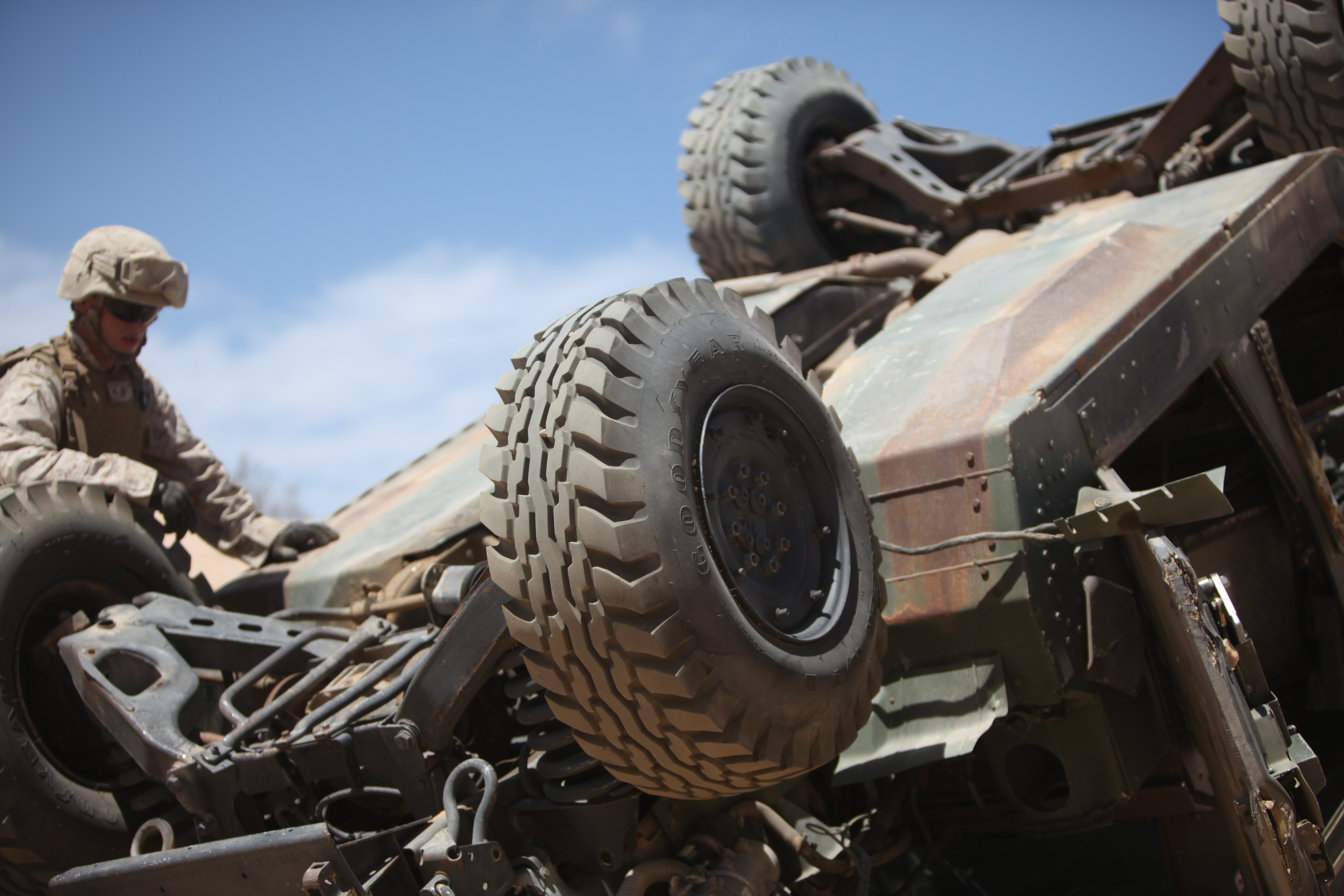 A Marine checks an obsolete Humvee during a vehicle recovery training ...
