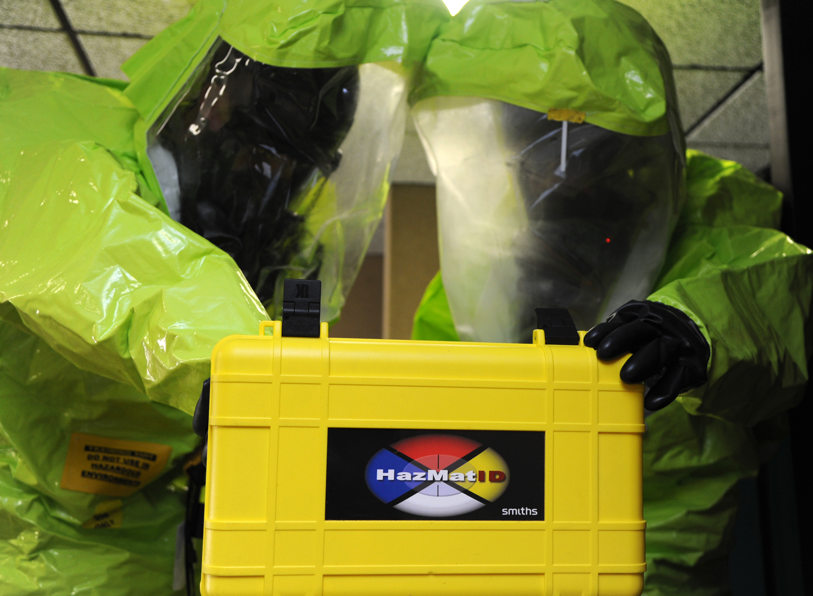 Two men collect haz-mat material