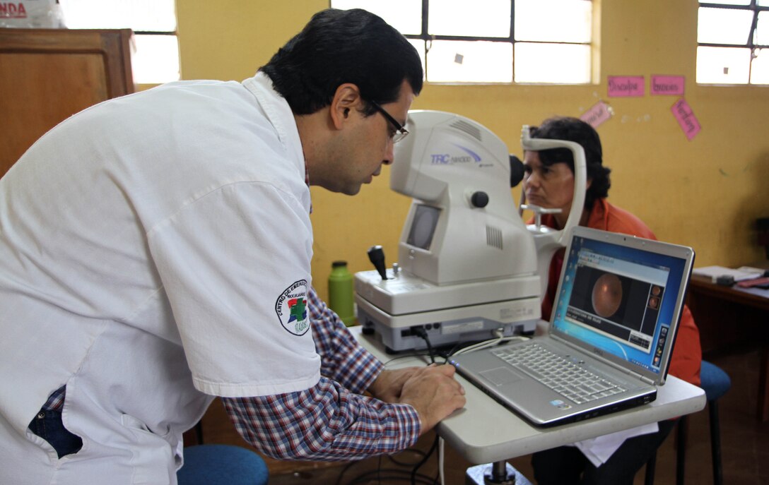 A Paraguayan ophthalmologist examines a local woman in the Canindeyú ...