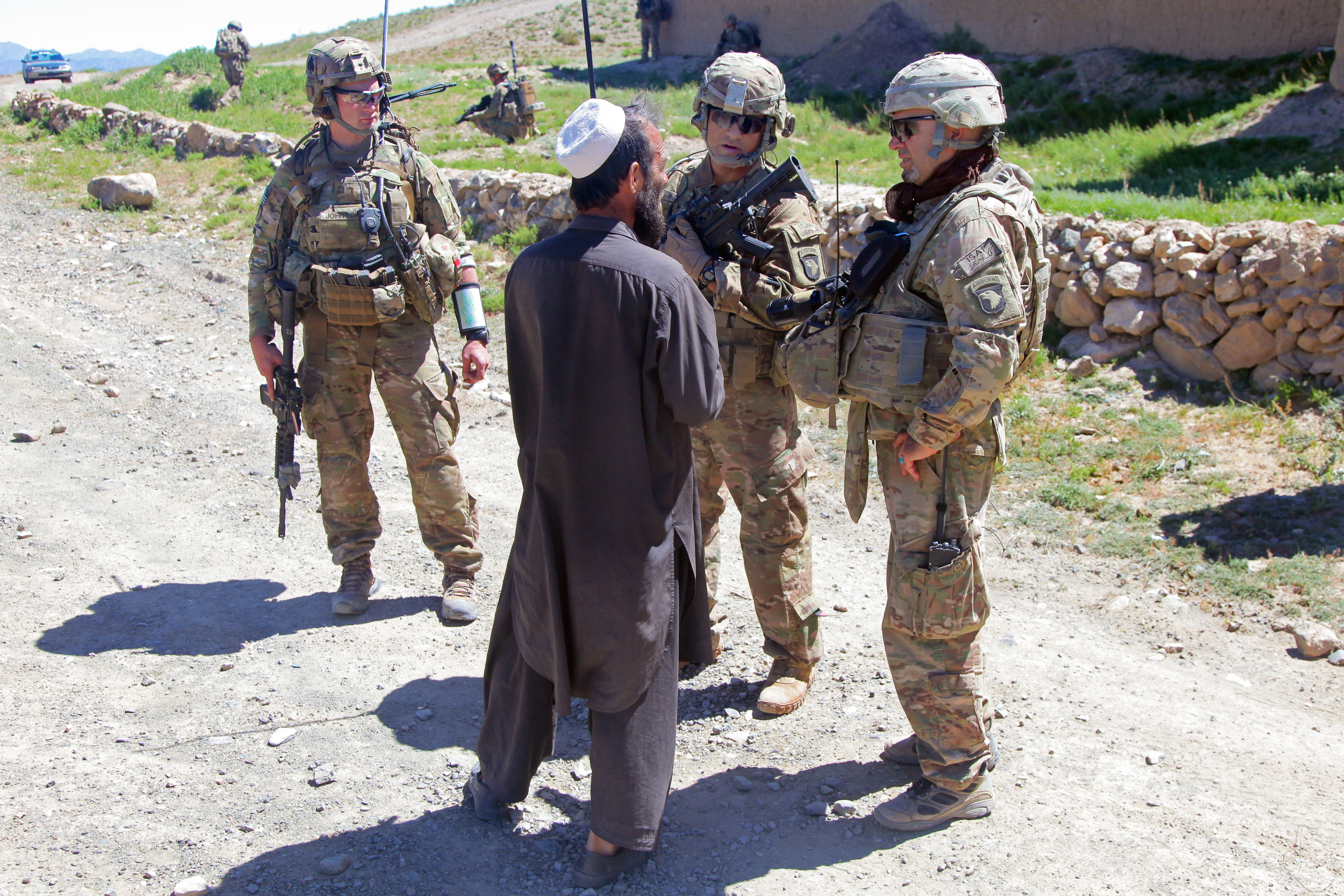 U.S. Army Capt. Alex A. Kaivan, center right, speaks with a local ...