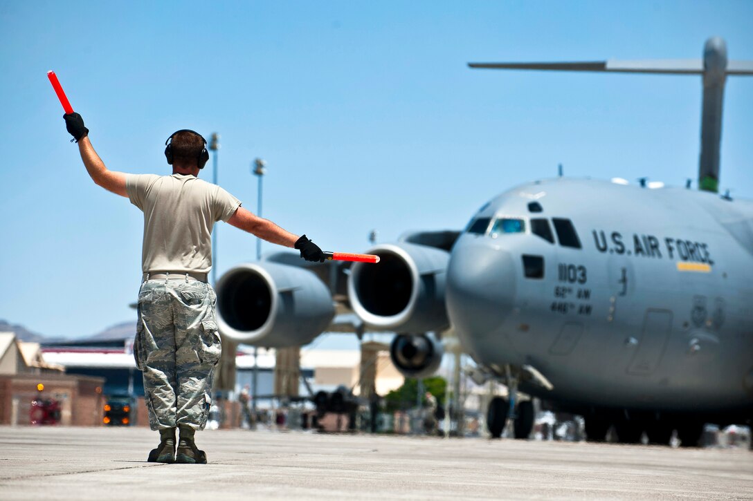 Air Force Senior Airman Jeremy Soylie directs a C-17 Globemaster III ...