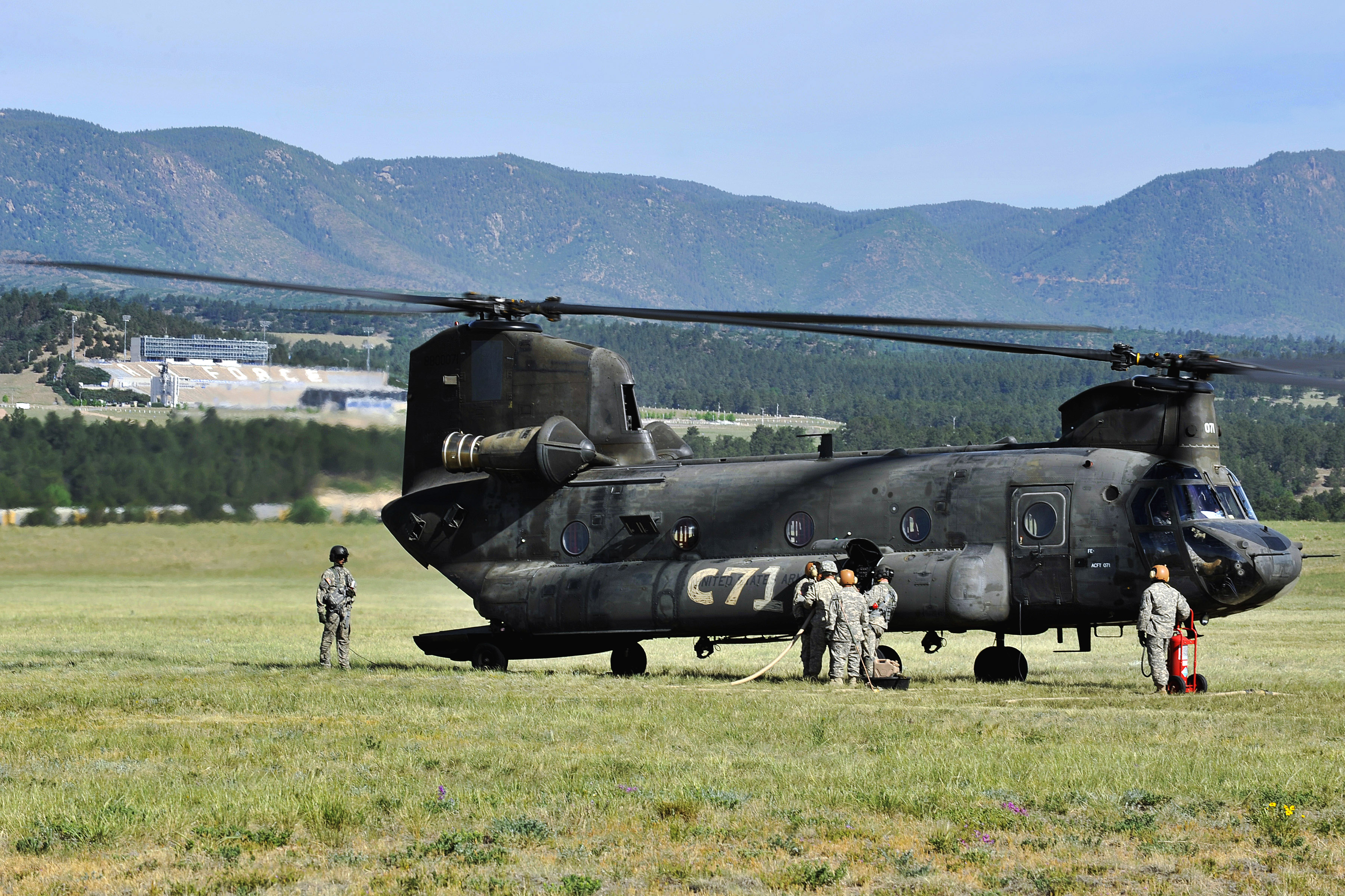 A UH-47 Chinook helicopter crew receives fuel at a Forward Area ...