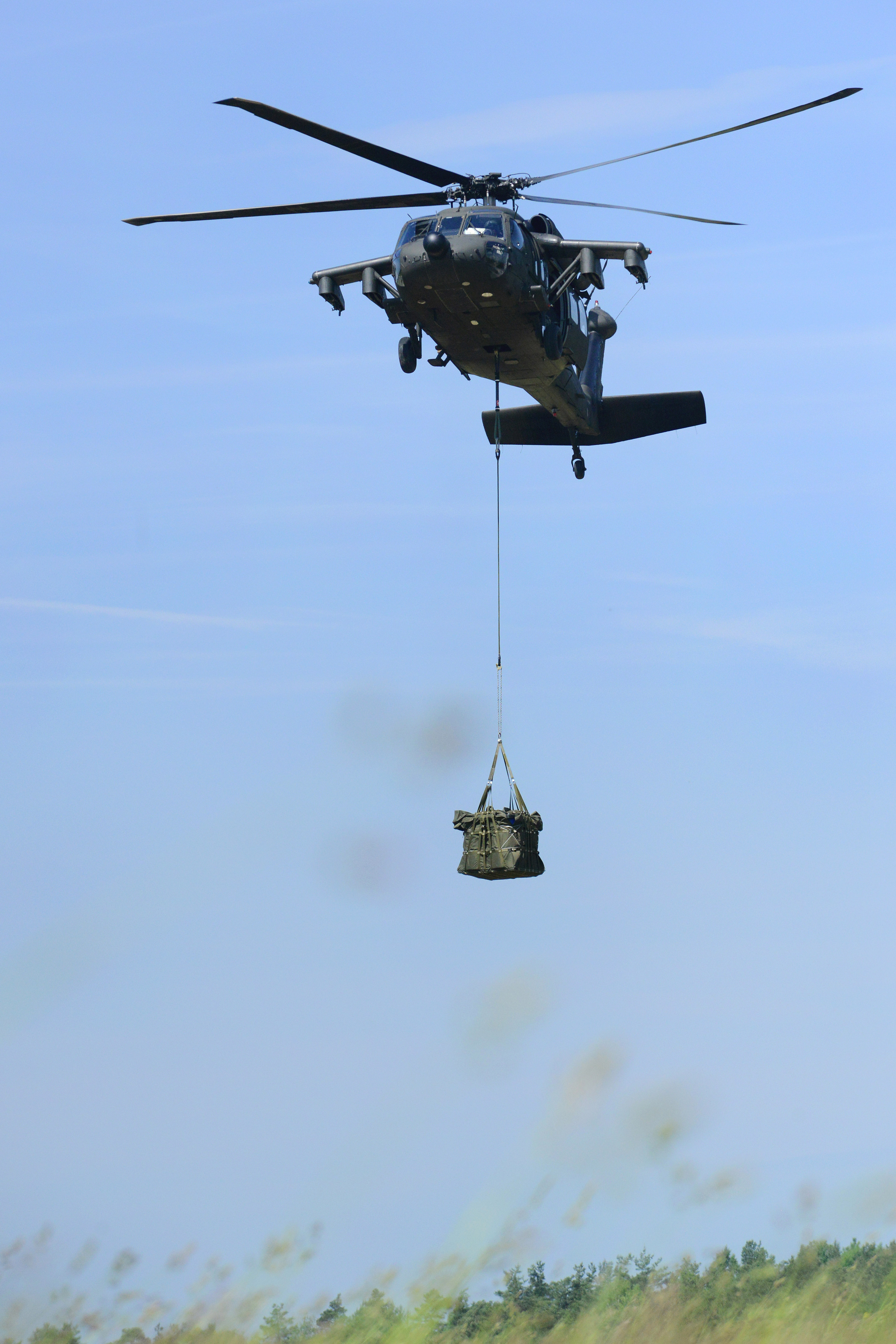 A UH-60 Black Hawk helicopter lifts off after soldiers hooked up a ...