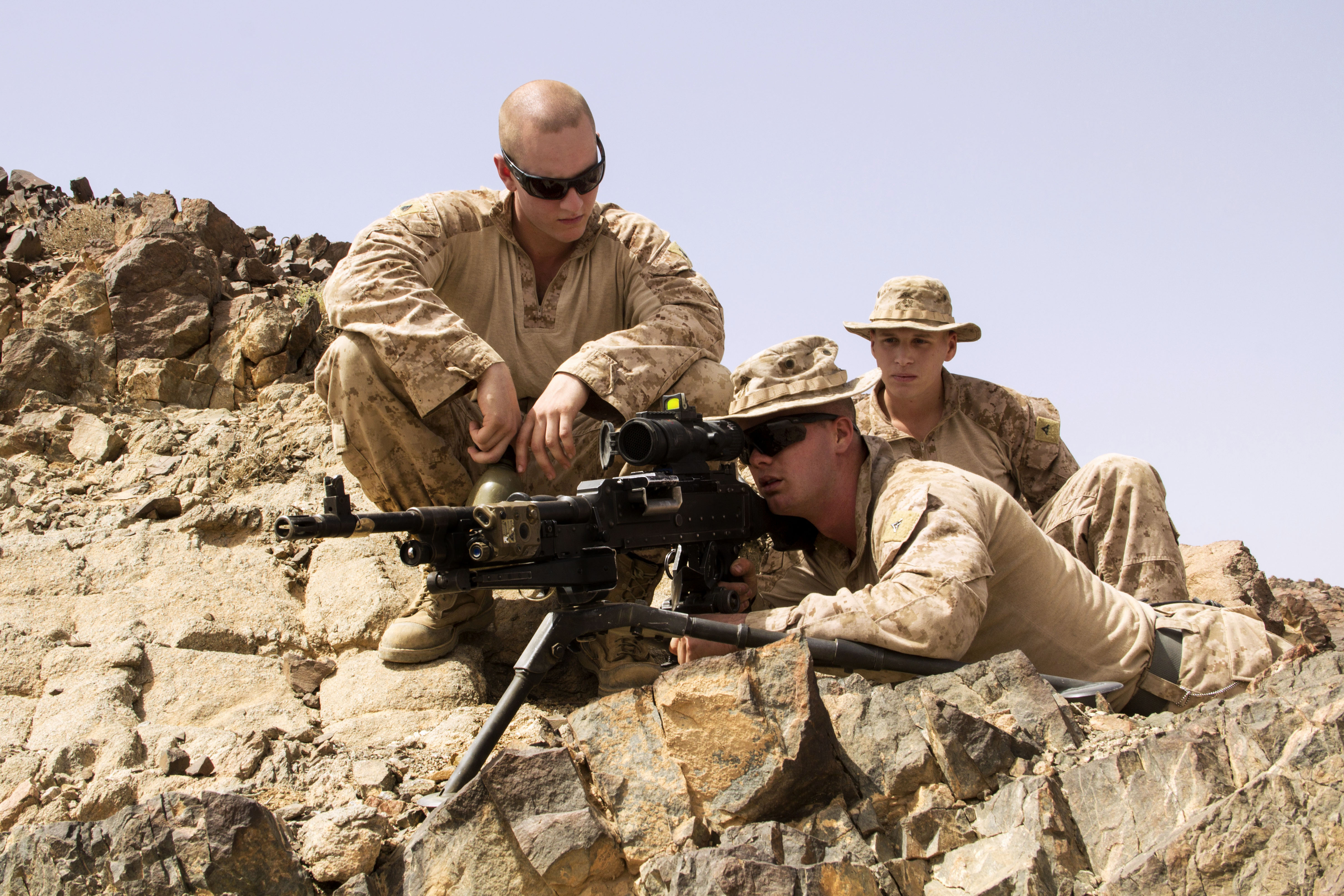 U.S. Marines gauge the distance of targets using the optic lens on a ...