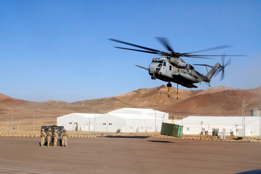 U.S. Marines prepare to attach a quadcon to a CH-53E Super Stallion ...