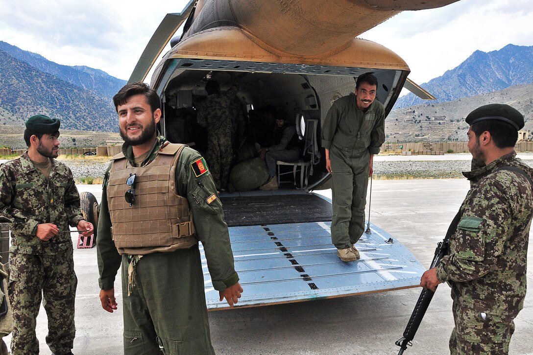 Afghan air force personnel pack their helicopter with Afghan border ...