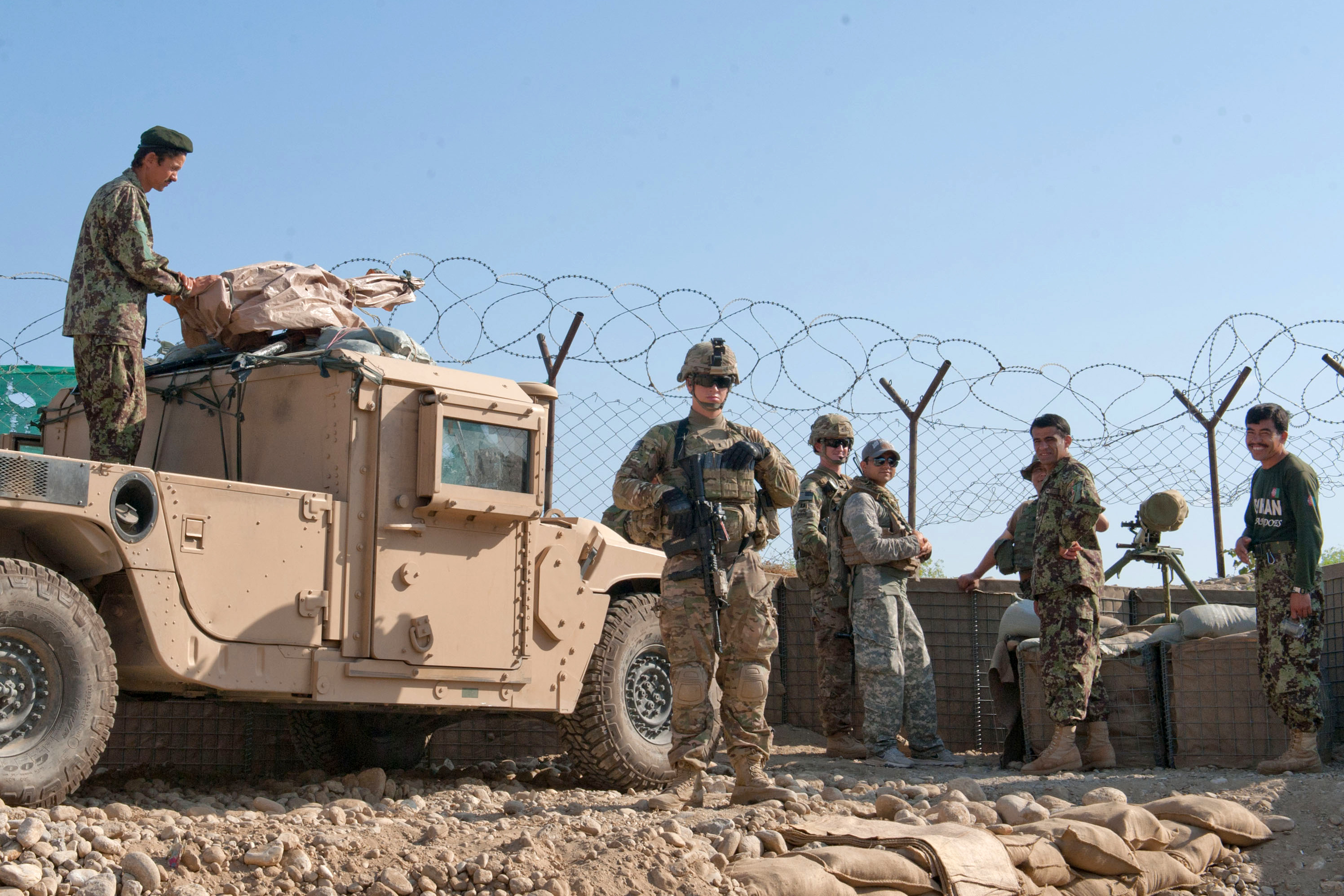 U.S. and Afghan army soldiers prepare to move out on a patrol to visit a security checkpoint on ...