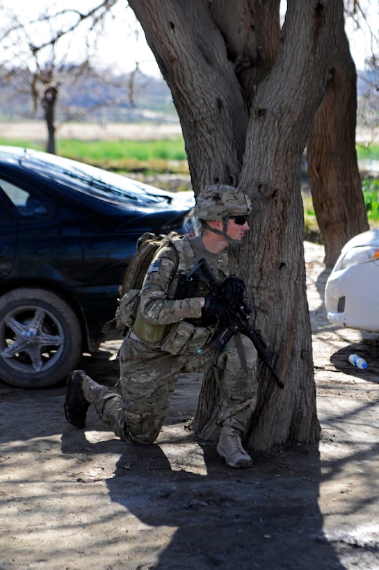 U.S. Army Spc. Christopher Carden provides security during a meeting ...