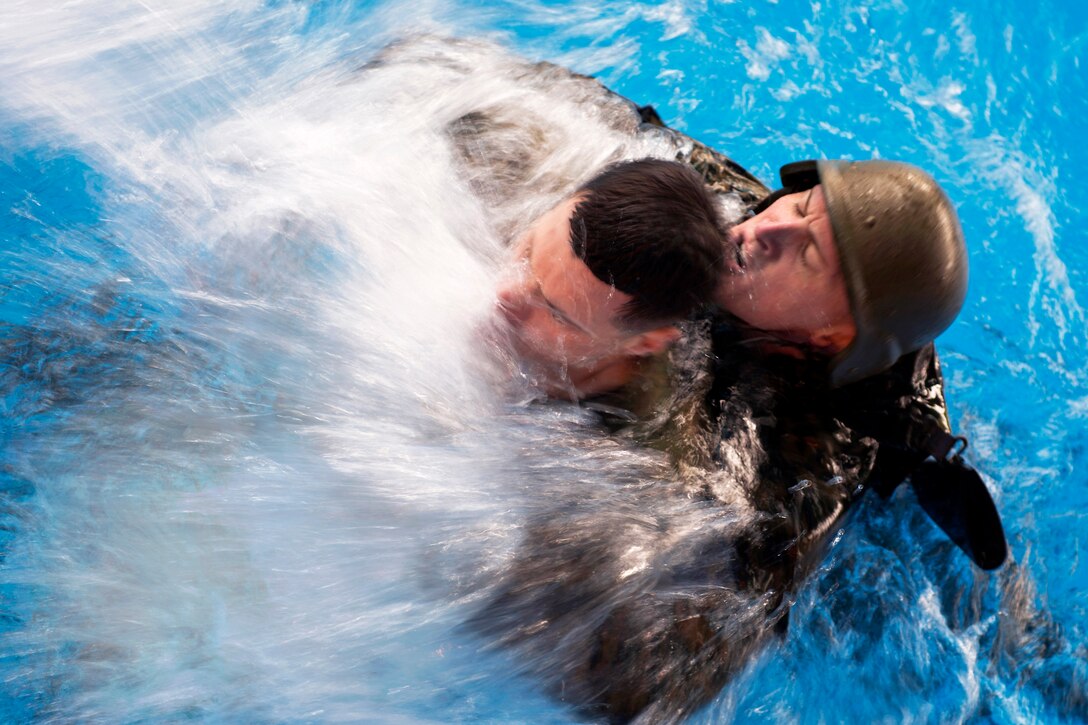 Marine Corps Capt. John Davis and Marine Corps Staff Sgt. Joseph Wells ...