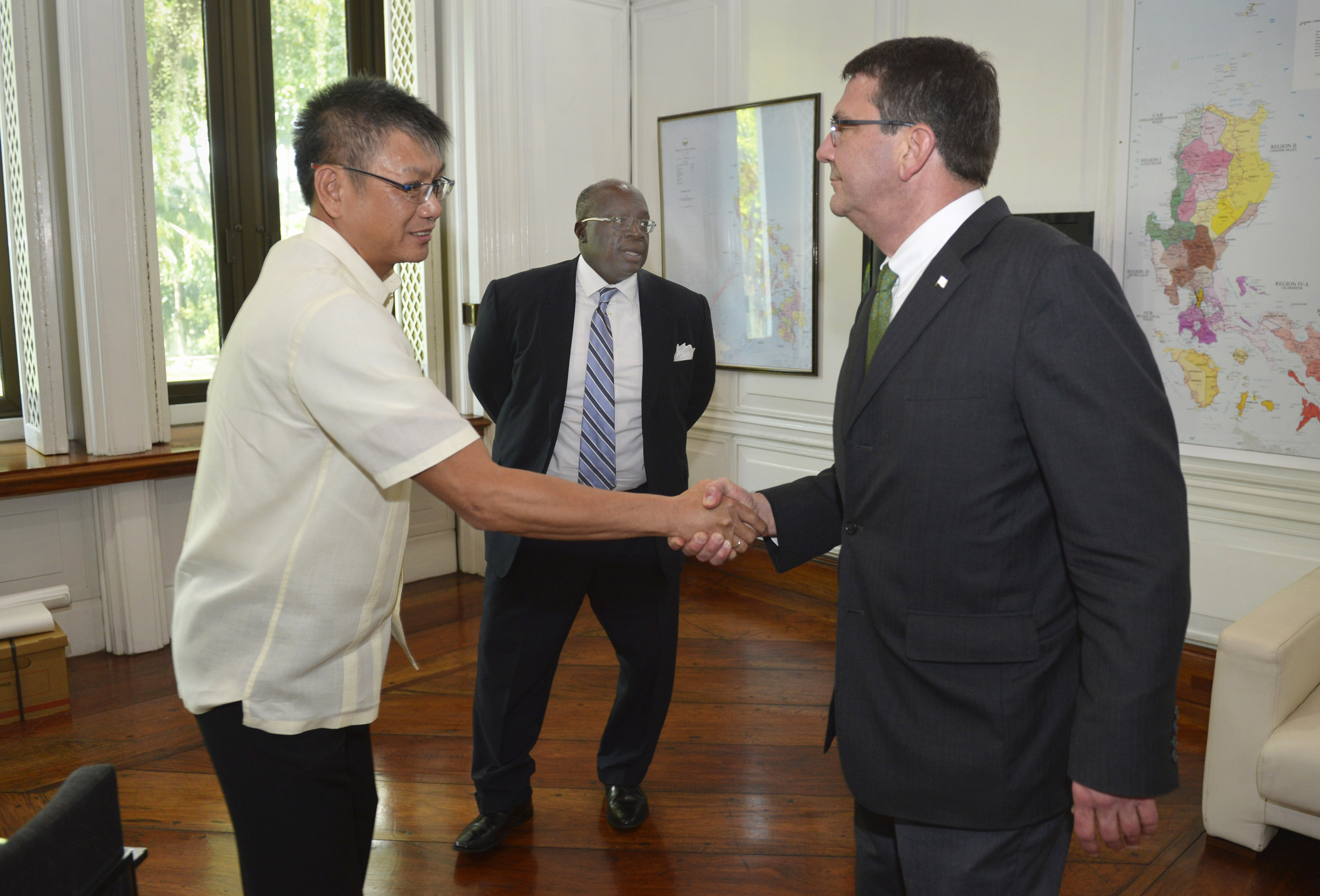 U.S. Deputy Defense Secretary Ash Carter, right, shakes hands with ...