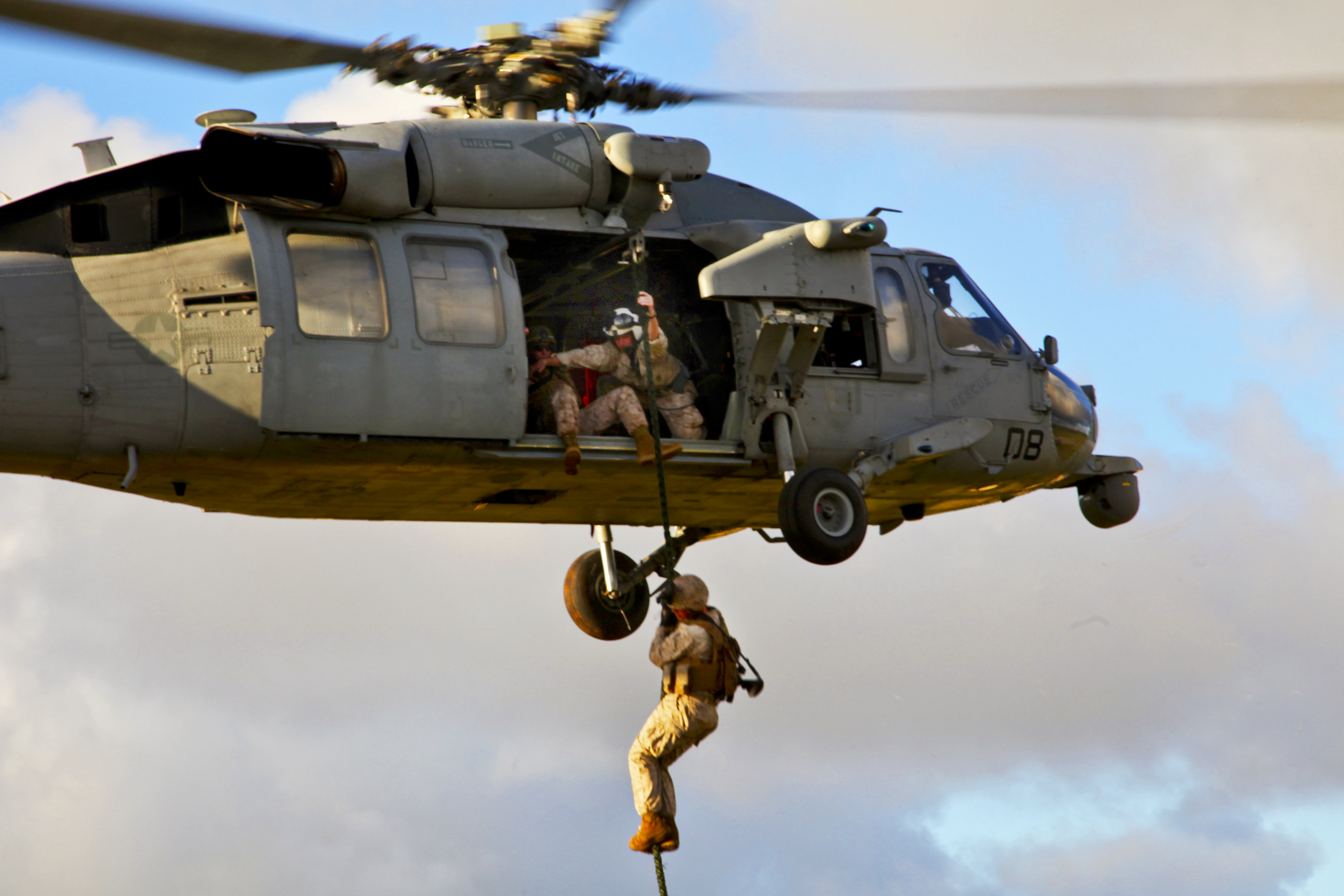 Marines fast-rope from an MH-60S Knighthawk helicopter and set up a ...