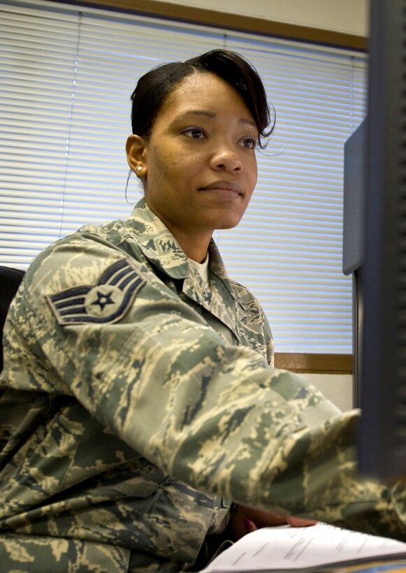 Air Force Staff Sgt. Tarheisha Alvarez updates an airman's profile on ...