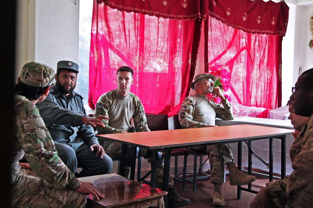 U.S. Army Capt. Kellen Blythe, third from right, talks to his ...