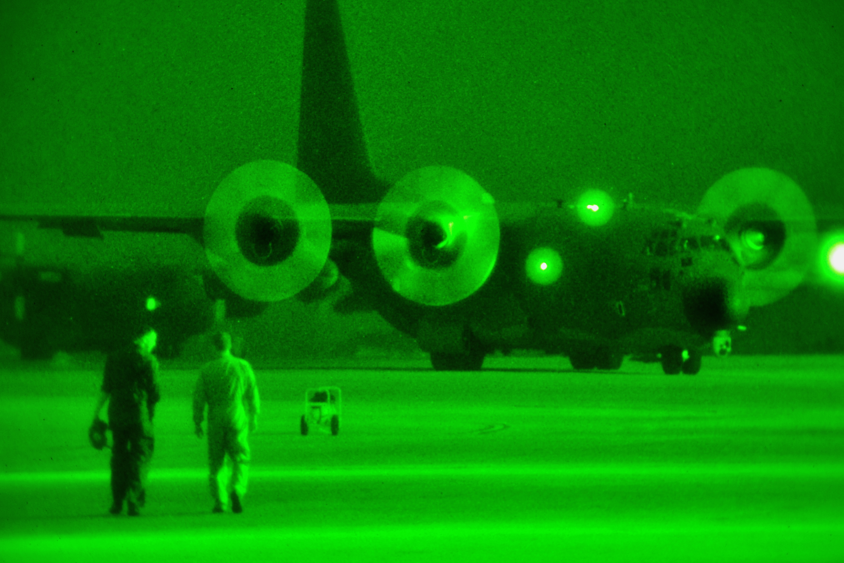As seen through a night-vision device, a U.S. Air Force C-130 Hercules ...