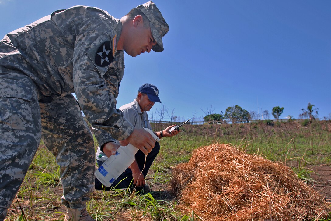 Army Sgt. 1st. Class Carlos J. Garcia, right, and a member of the ...