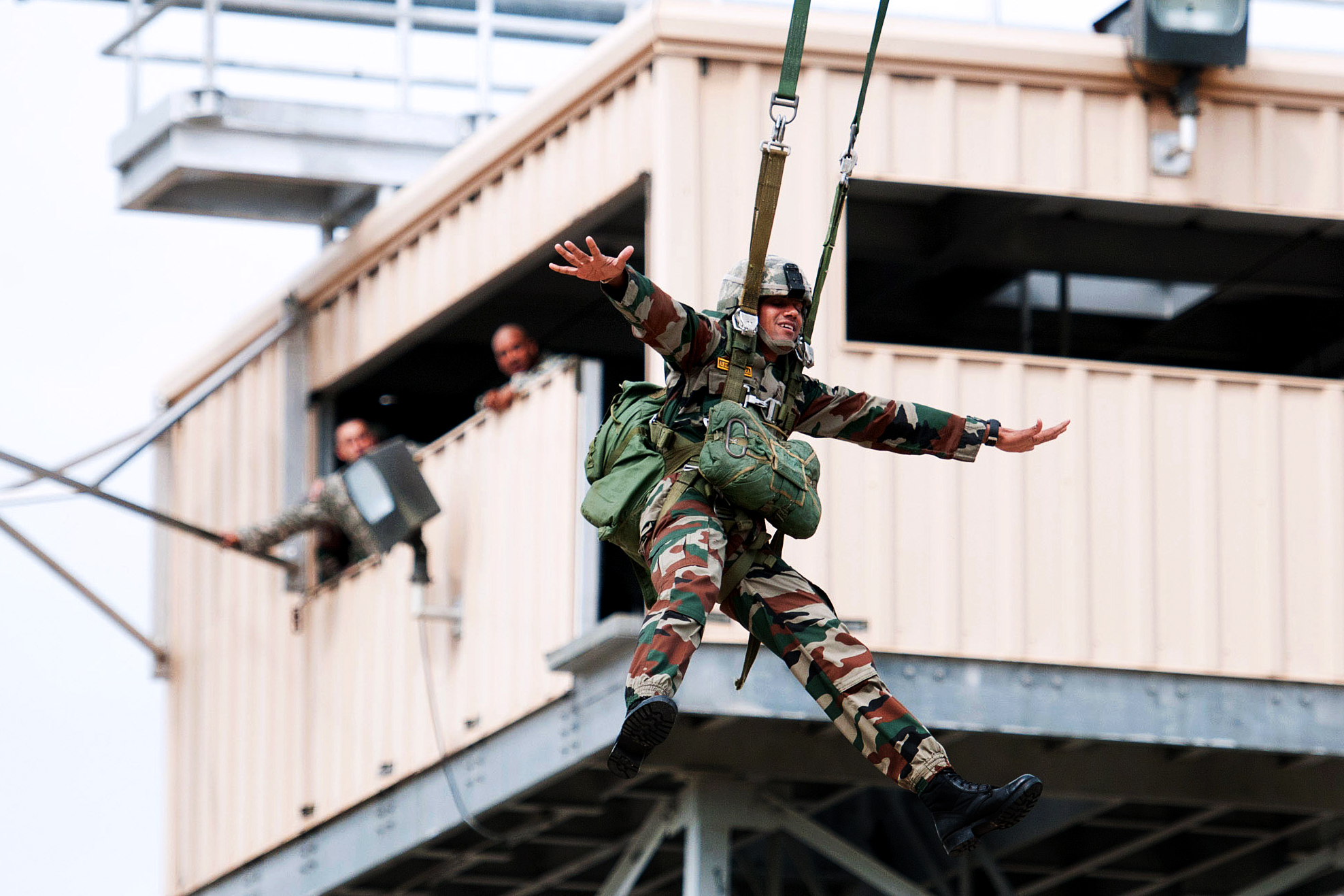 An Indian army paratrooper exits a 34-foot training tower at the 82nd ...
