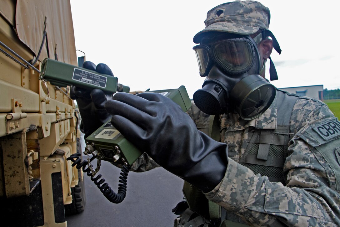 Army Spc. Jerame Smalls checks a vehicle for radiation at the first ...