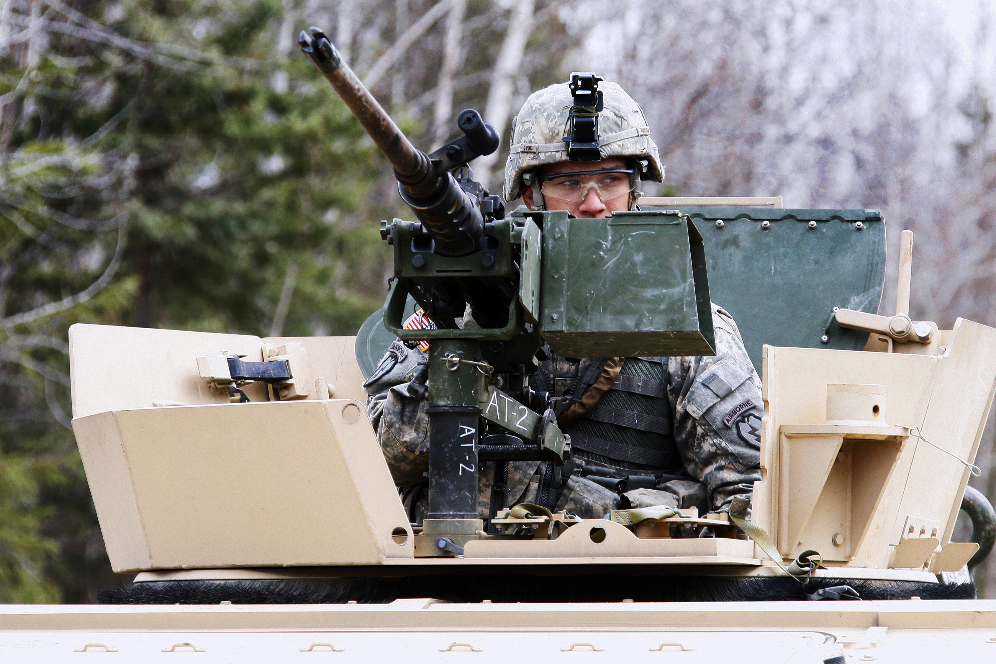 Army Spc. Joshua Kanavalov watches for activity as his convoy moves to ...