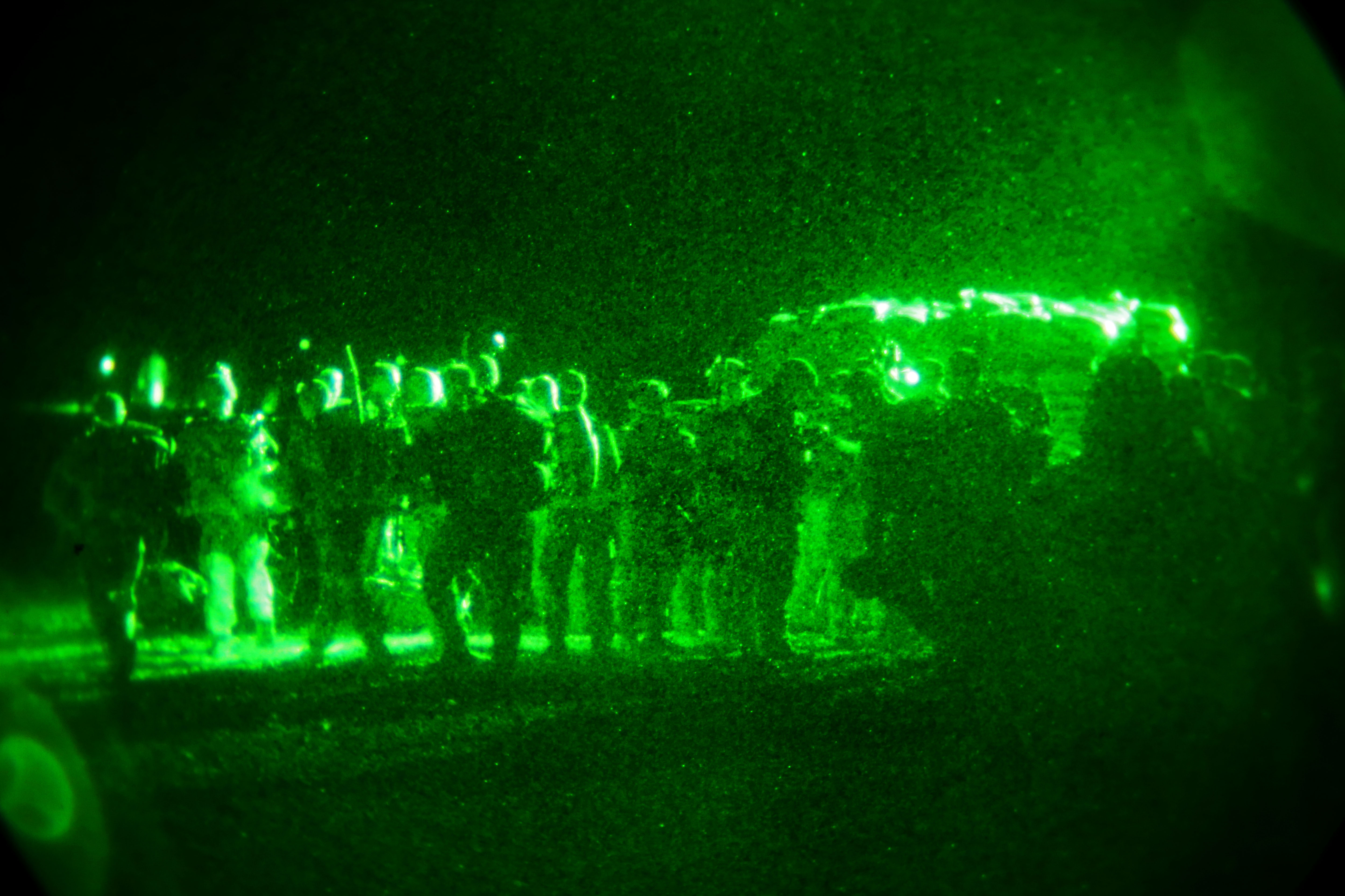 As seen through a night-vision device, U.S. soldiers prepare for a ...