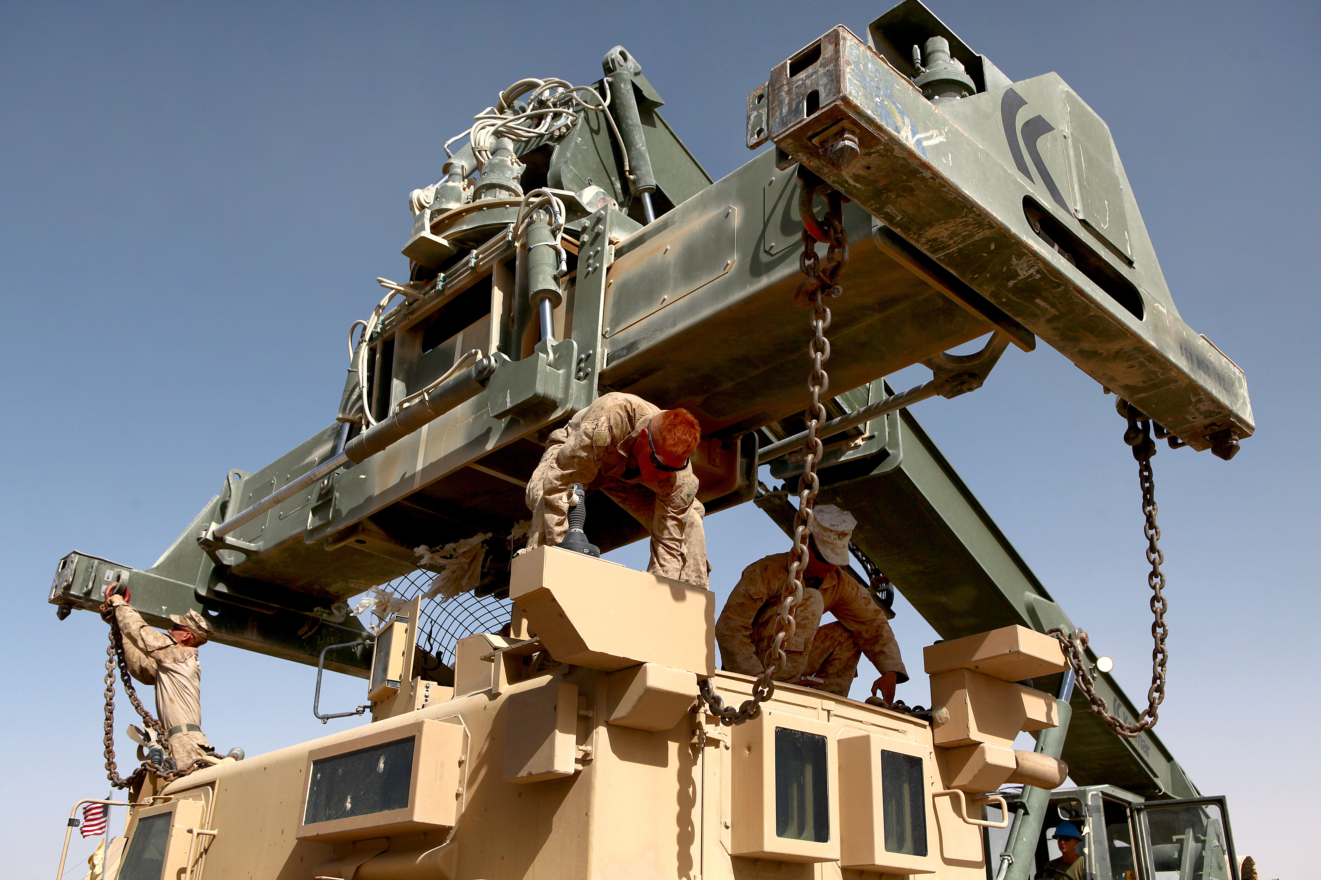 U.S. Marines fasten a damaged mine-resistant, ambush-protected vehicle ...