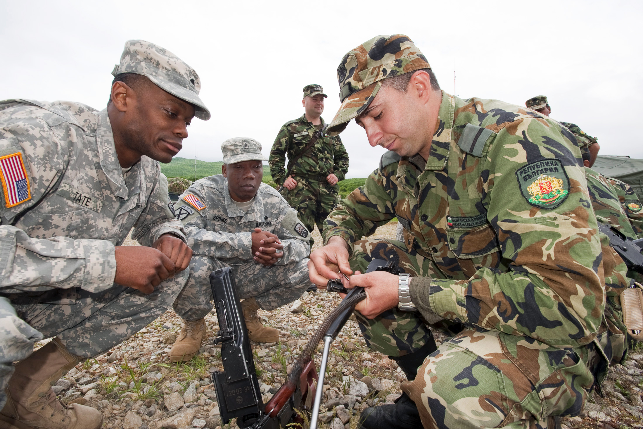 U.S. Army Spc. Tate, left, and U.S. Army Staff Sergeant Spinks, center ...