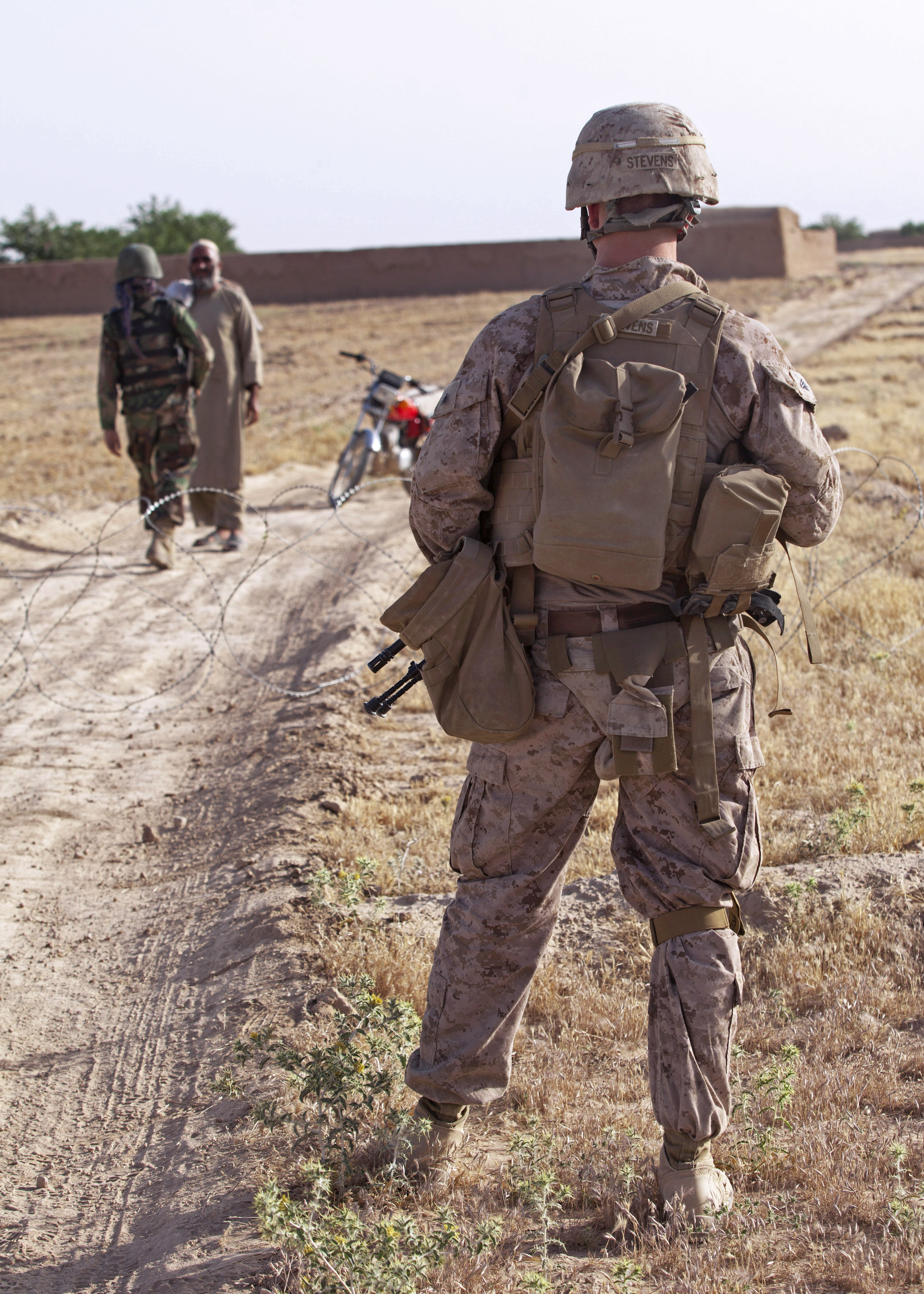 U.S. Marine Corps Cpl. Justin Stevens provides security for an Afghan ...