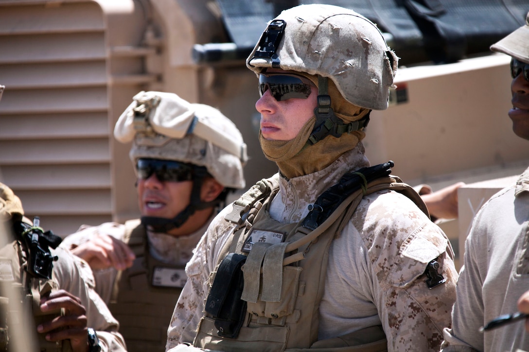 U.S. Marines listen during a mission debrief on Camp Delaram in Afghanistan’s Helmand province ...