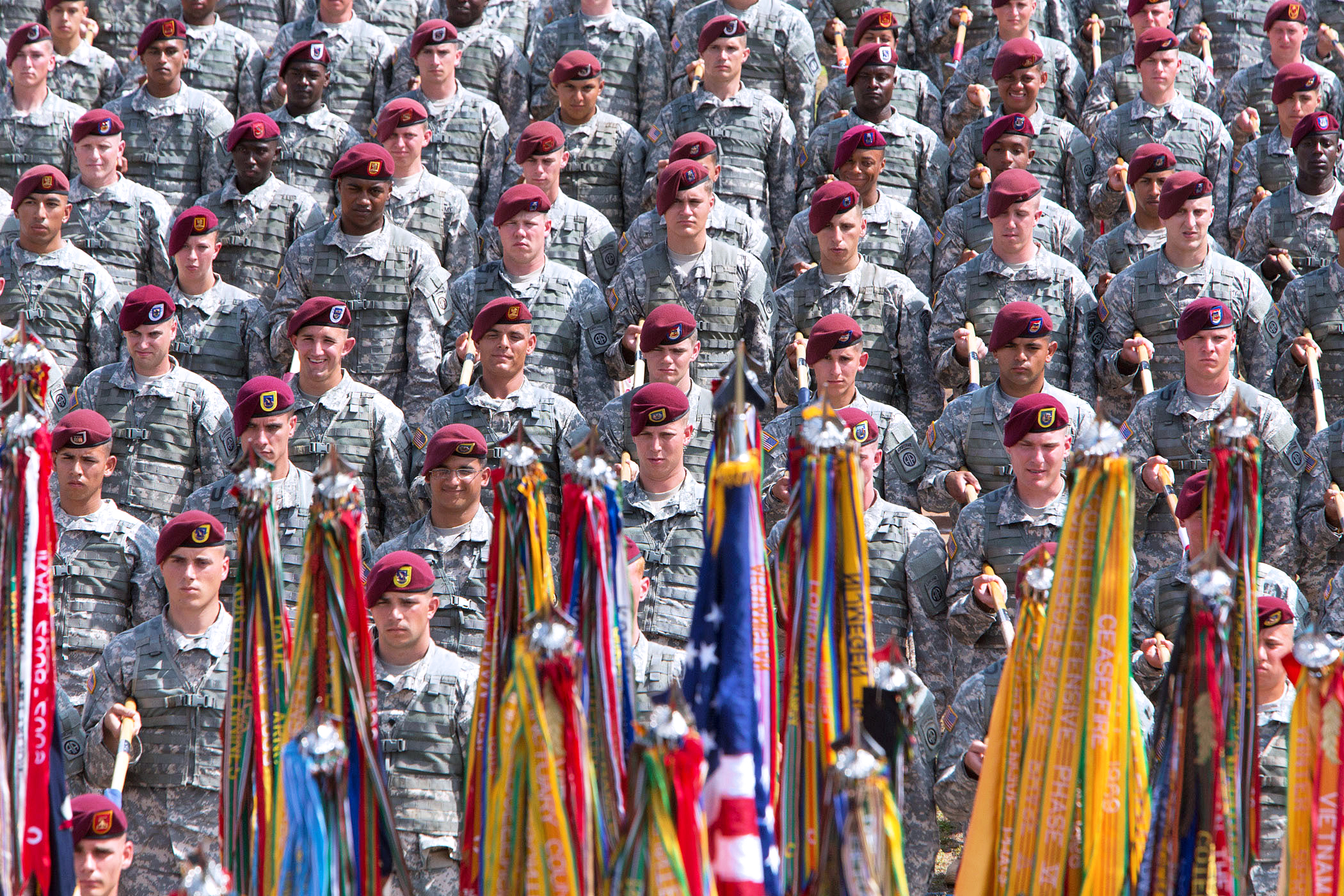 Paratroopers participate in a division review with their unit colors on ...