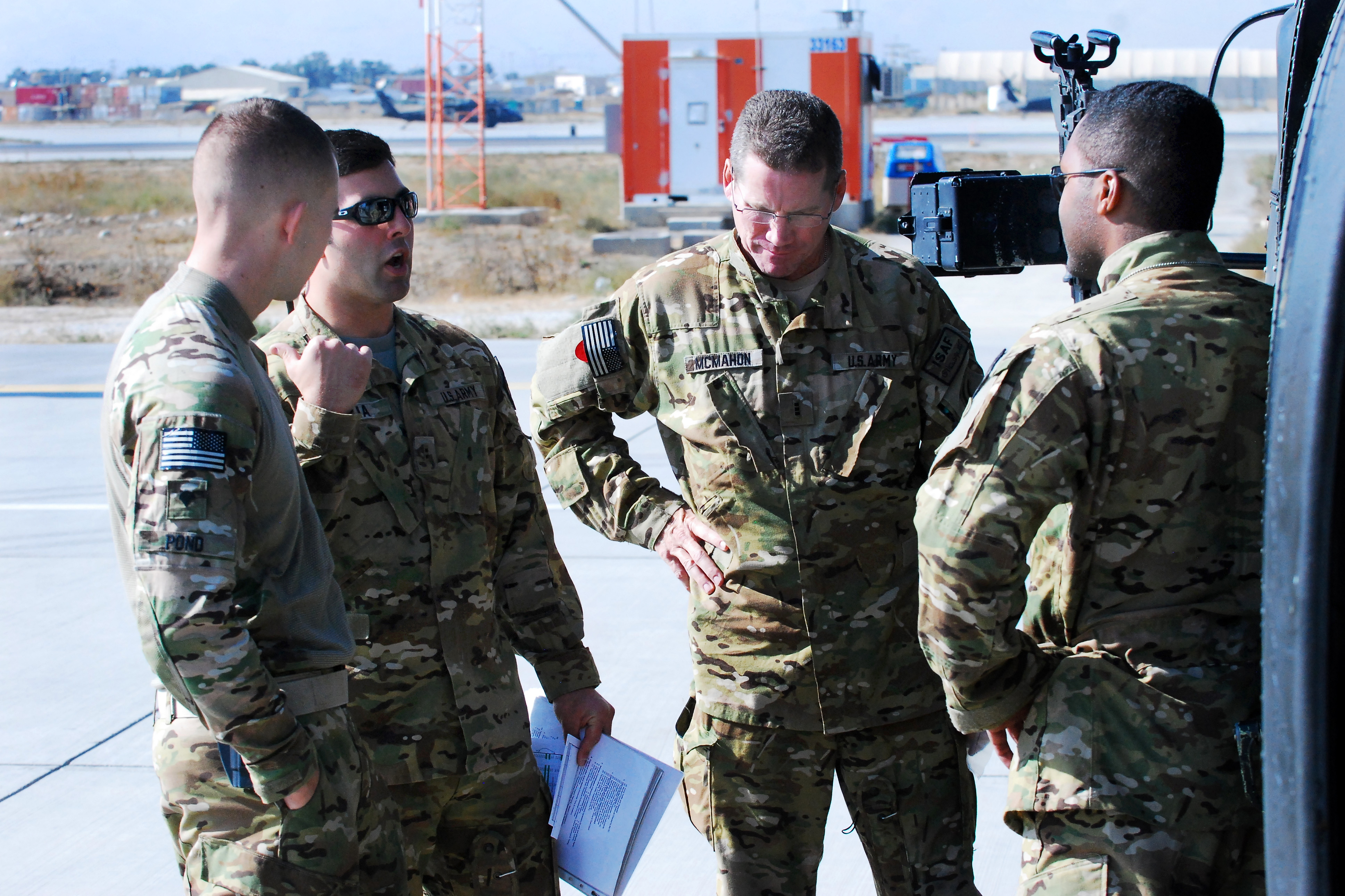U.S. Army Chief Warrant Officer 2 Tony Celia, second from left, gives a ...