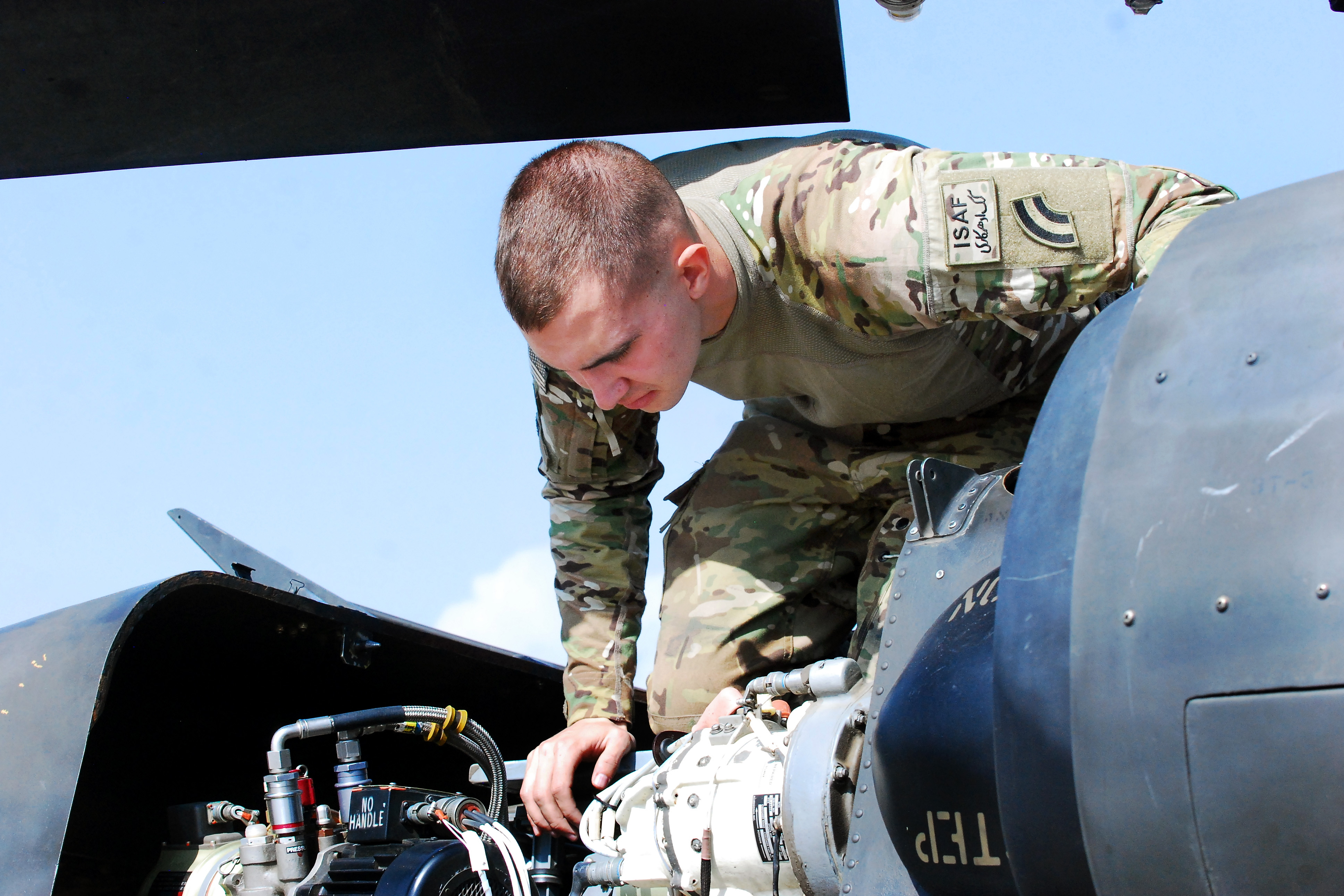 U.S. Army Spc. Christopher Pond performs a preflight inspection on a UH ...