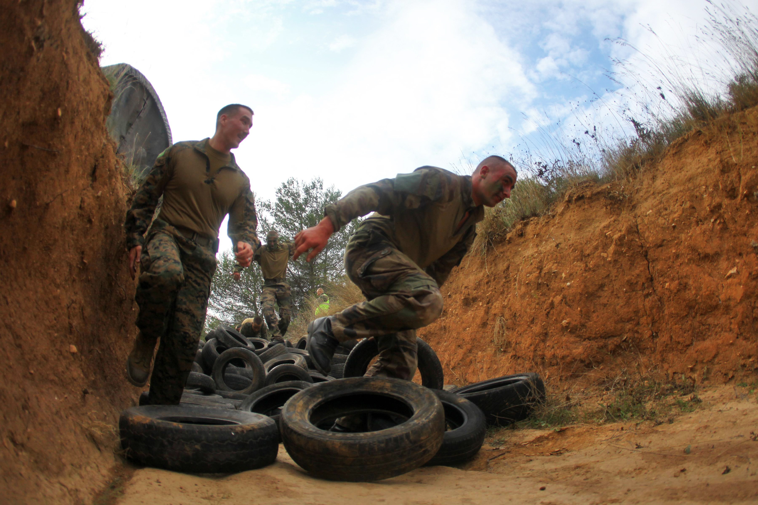 U.S. Marines and French legionnaires take part in an obstacle course ...