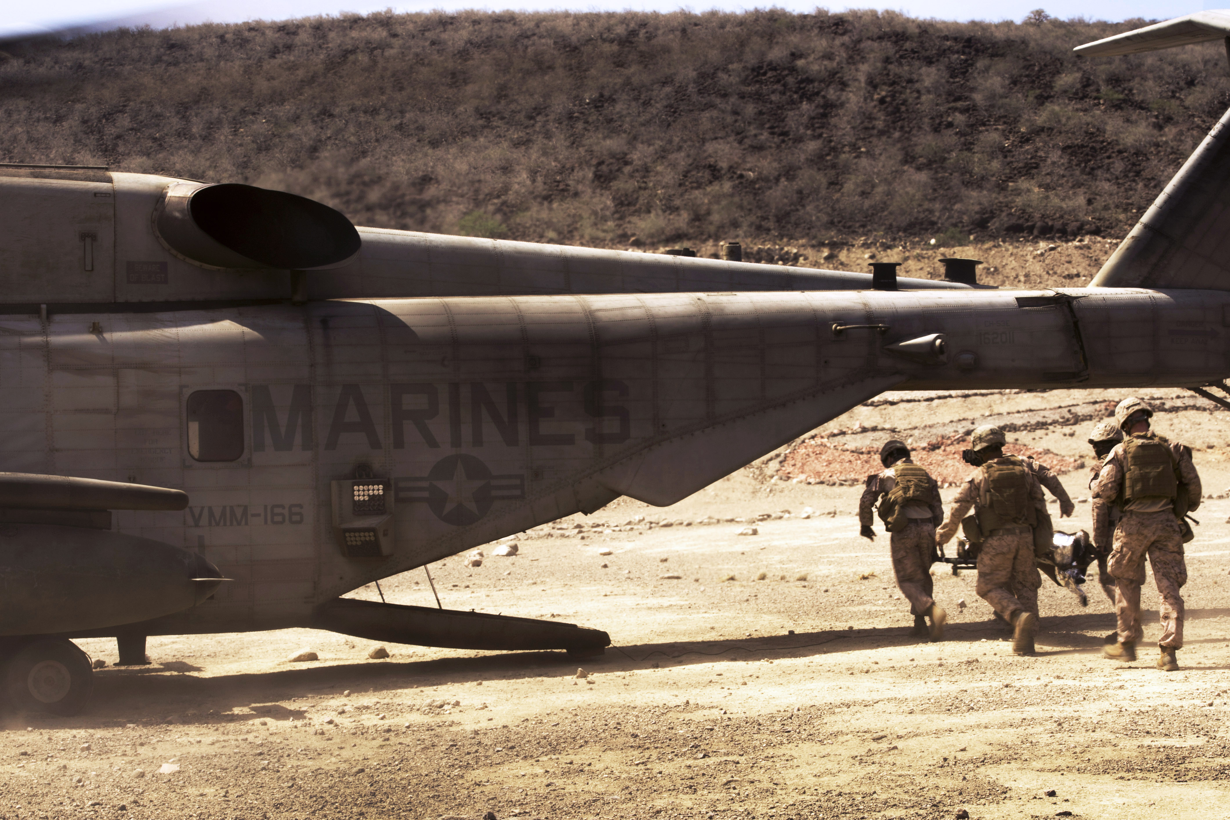 U.S. Marines carry a simulated casualty to a CH-53E Super Stallion ...