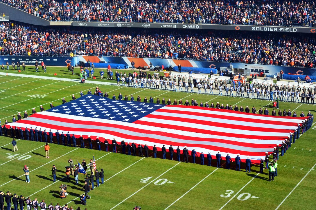Service members unfurl the ational flag during ceremonies before the ...