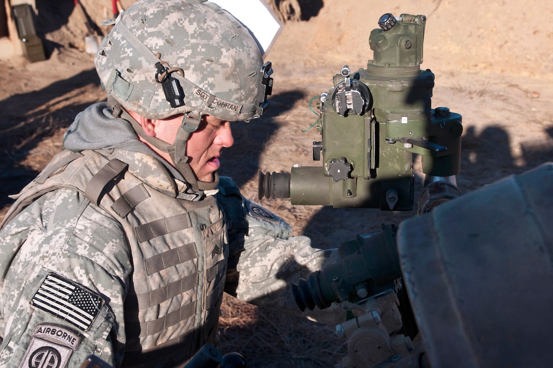 Army Sgt. Noah G. Cohran adjusts his sights during a live-fire exercise ...