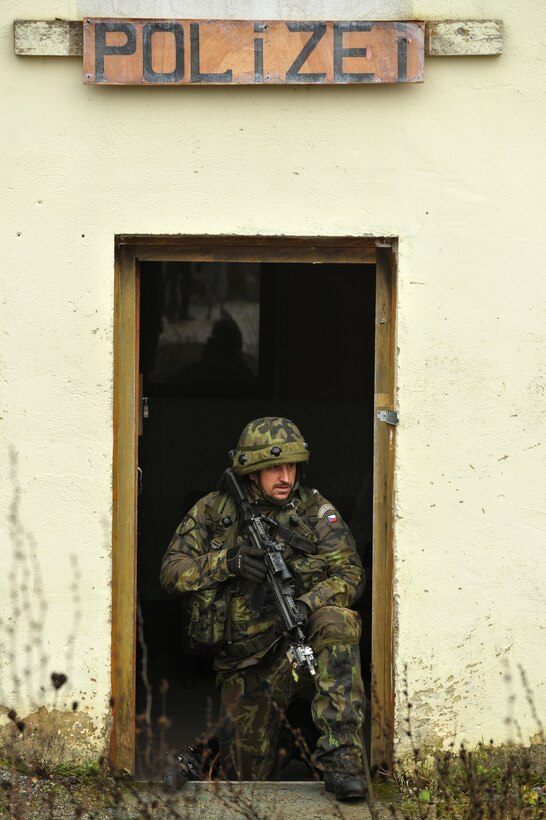 A Czech soldier provides cover while fellow soldiers conduct unified ...
