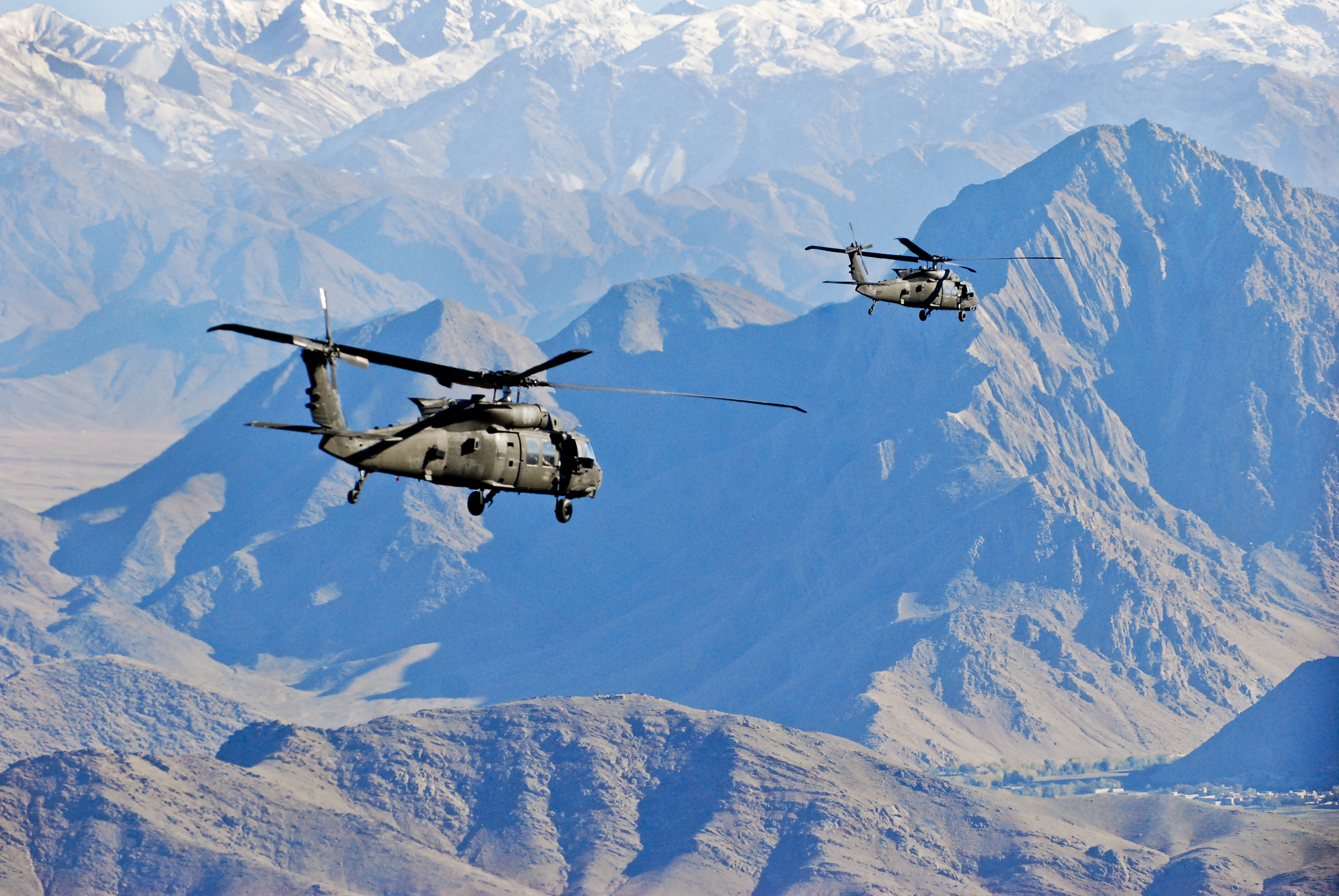 Two U.S. Army UH-60M Black Hawk helicopters fly over Logar province ...