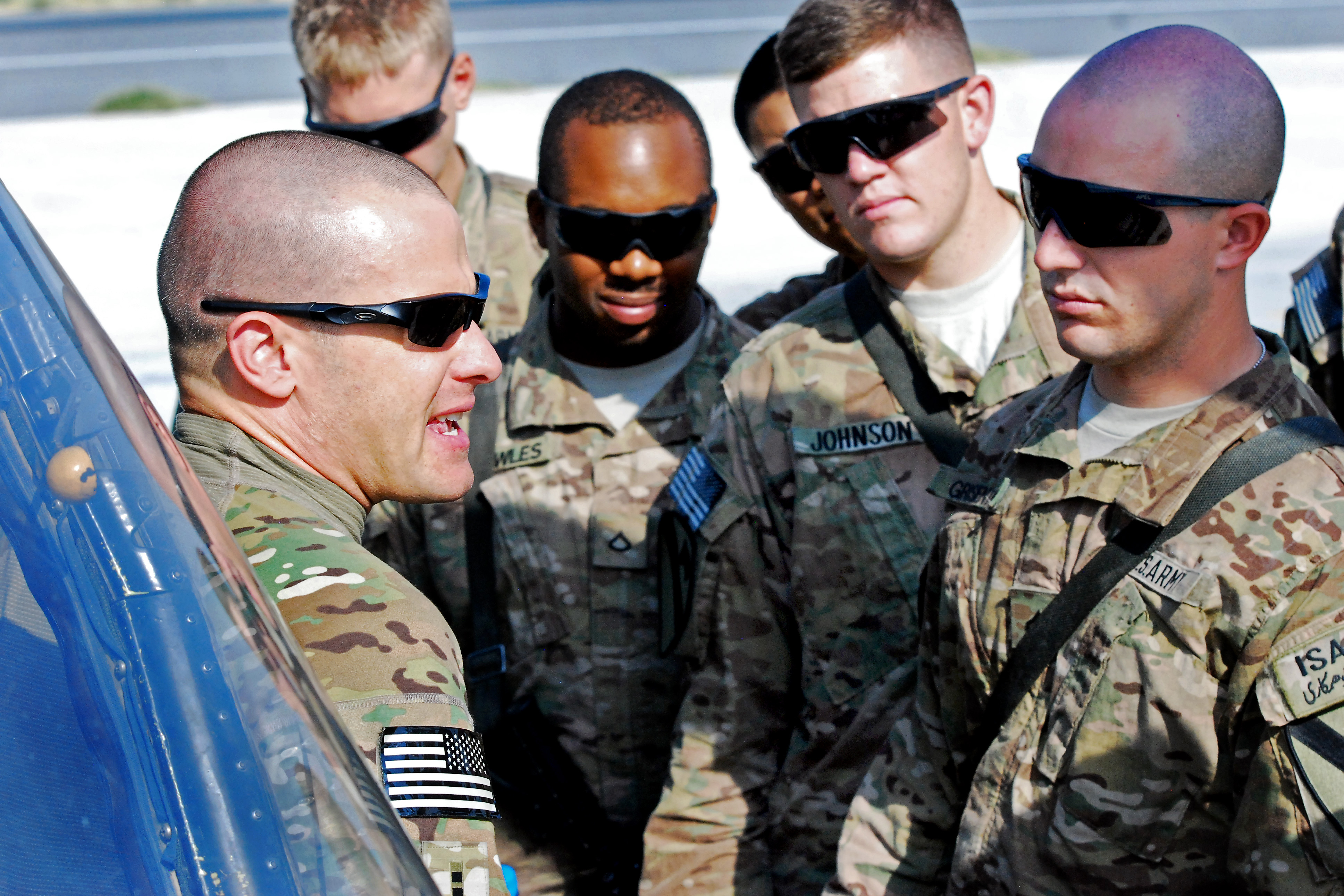 U.S. Army Chief Warrant Officer II William Hargrove, left, gives a ...
